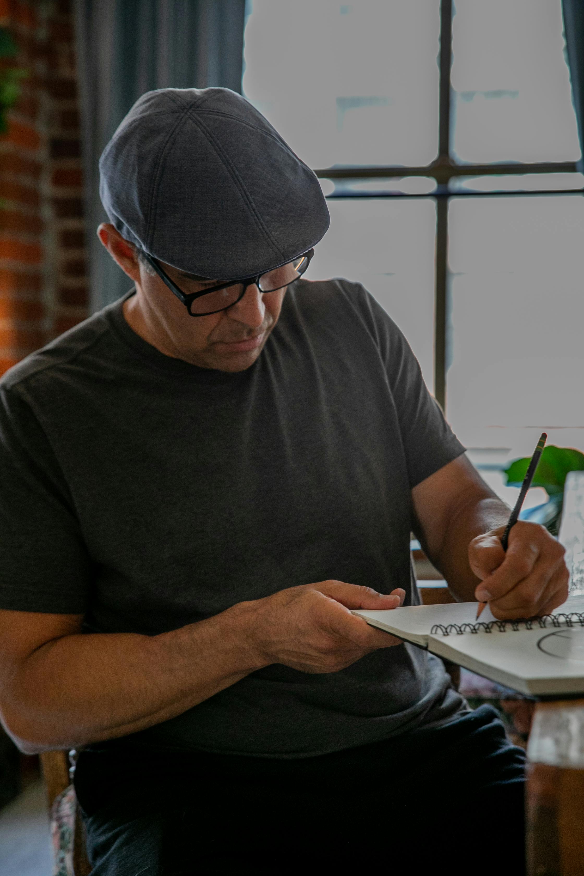 Man Drawing in Notebook · Free Stock Photo