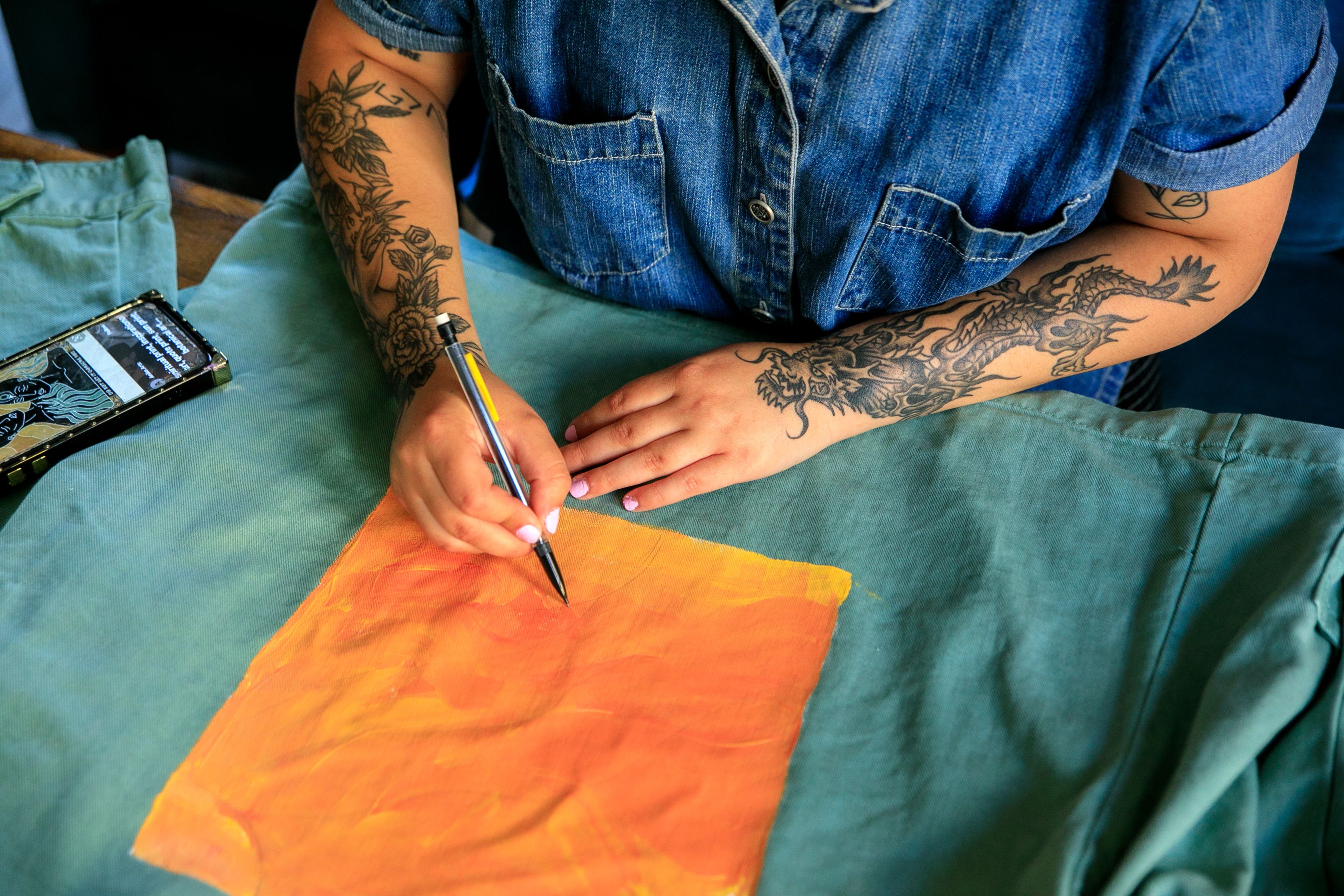 Man Drawing in Spiral Notebook · Free Stock Photo