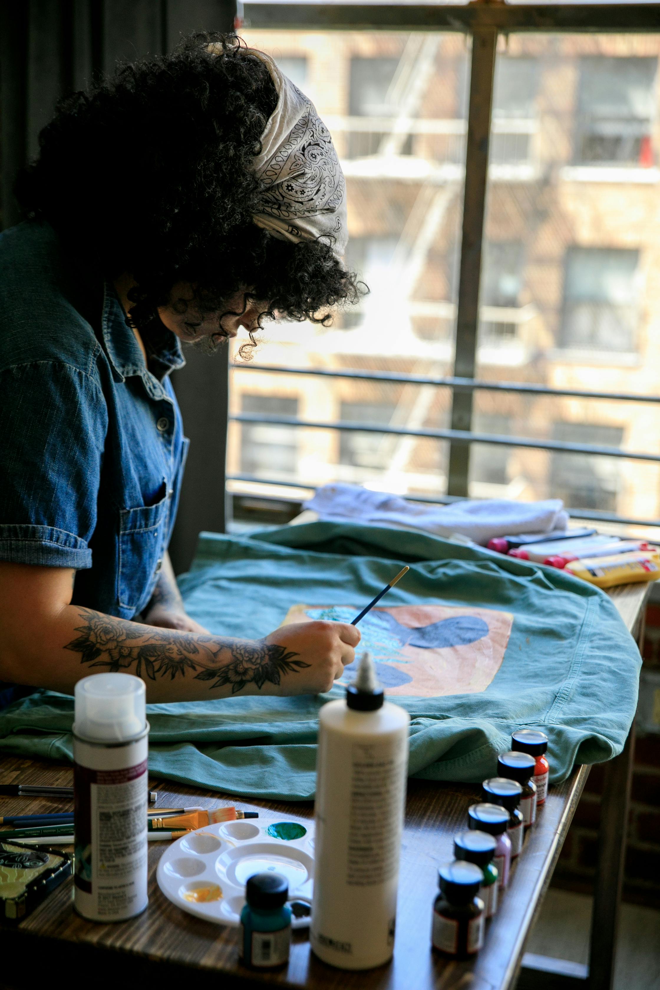 Curly Haired Artist Painting on Cloth · Free Stock Photo