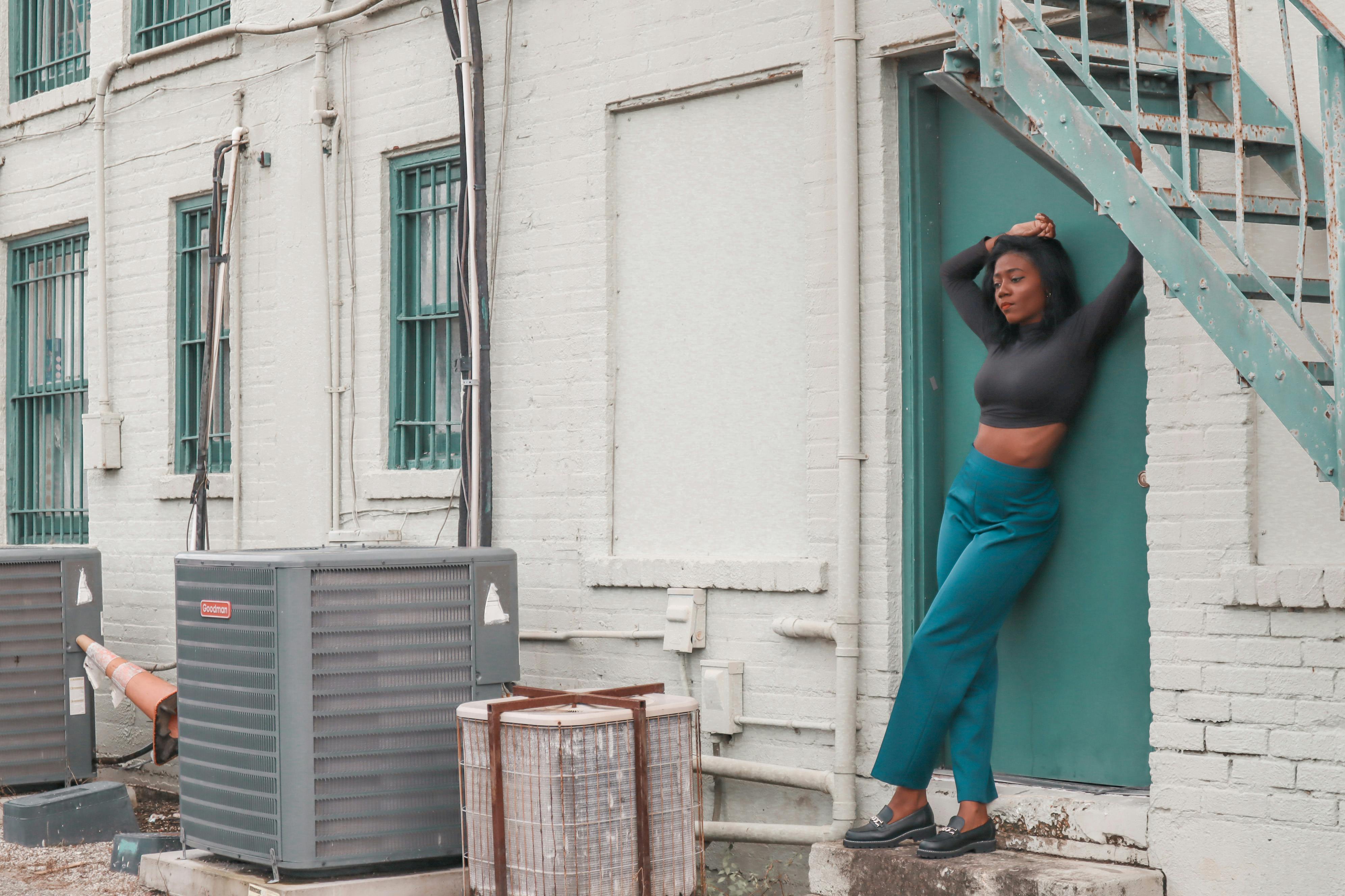 Beautiful Woman Leaning against the Door · Free Stock Photo