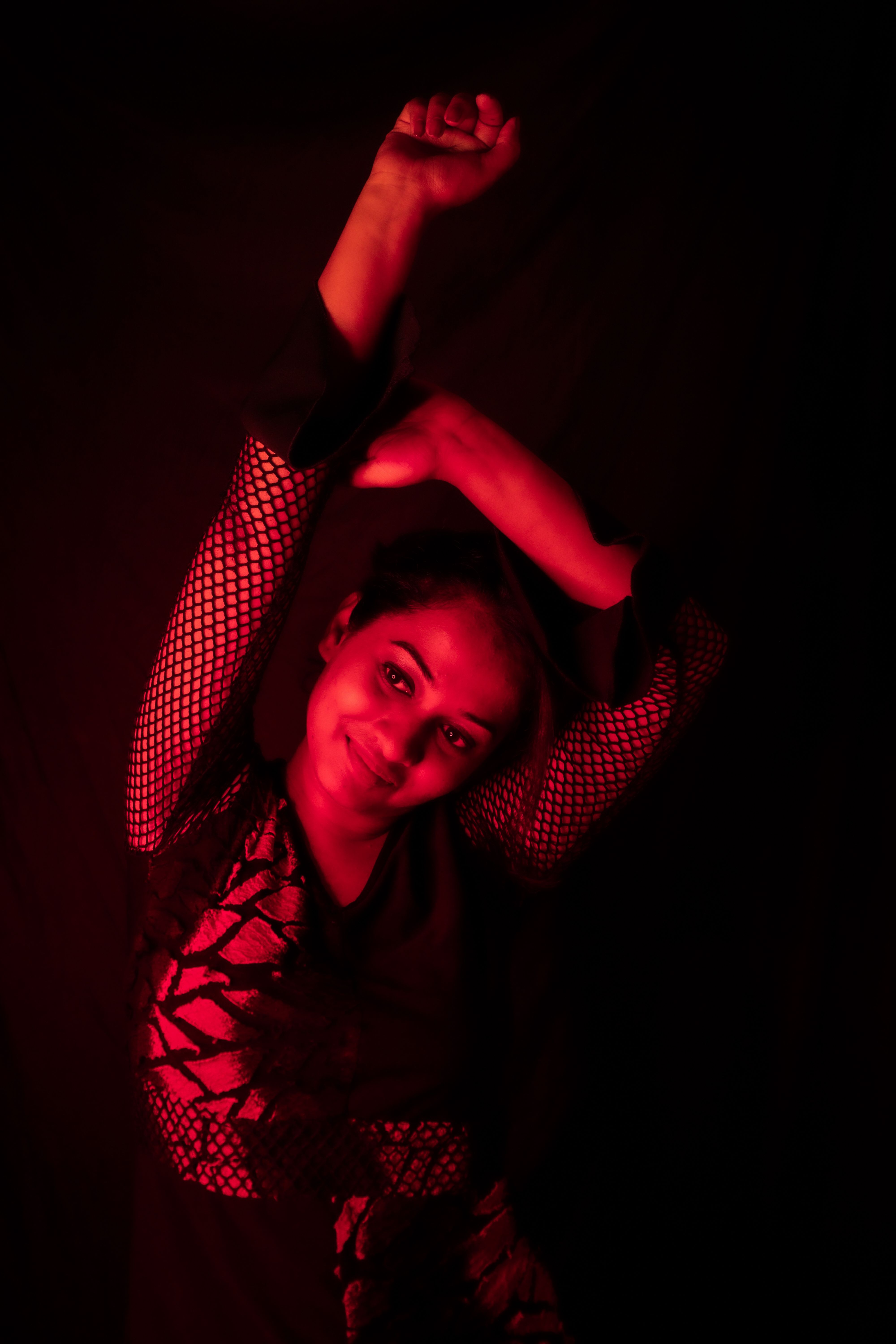 Young Woman Posing in Red Lighting · Free Stock Photo