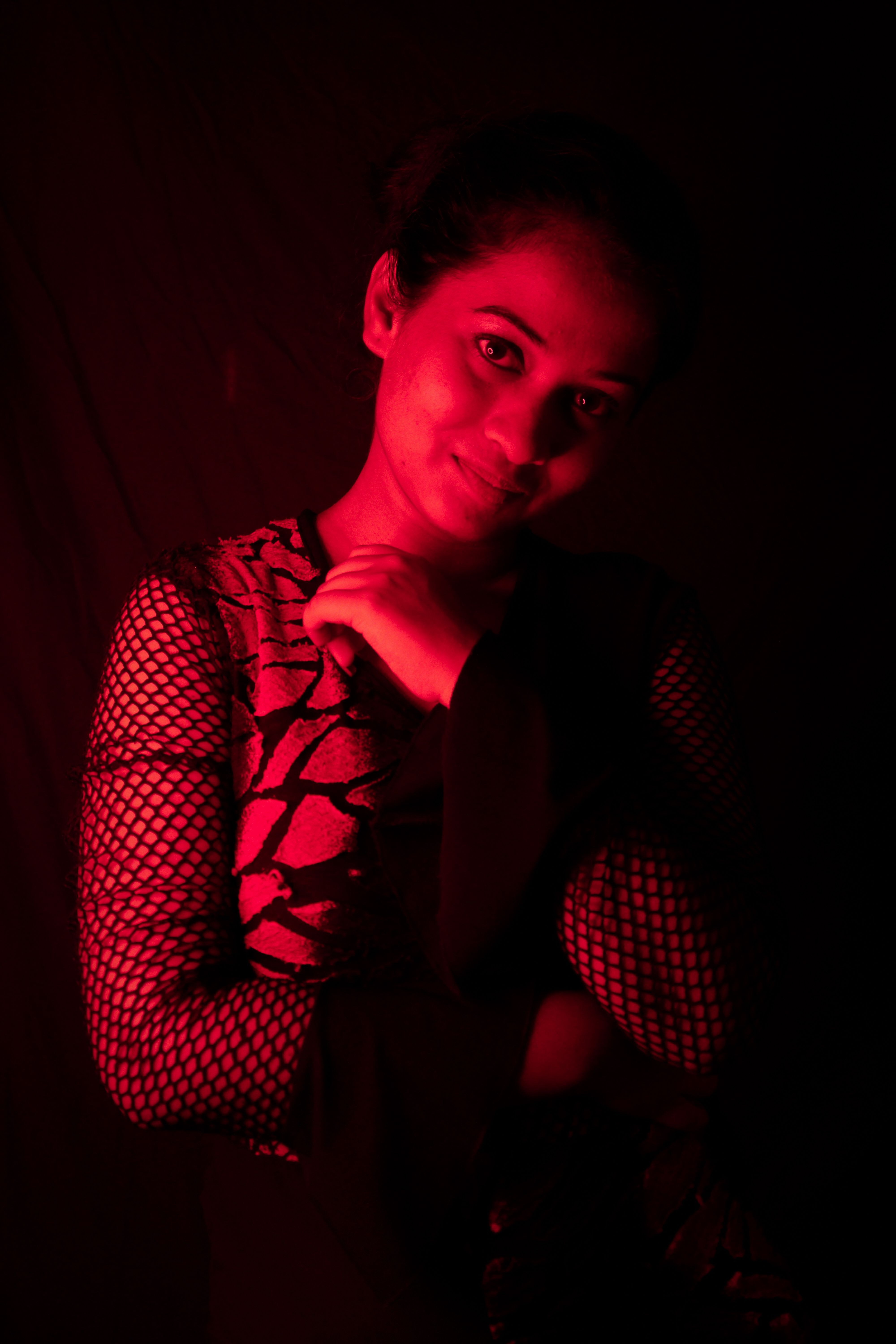 Young Woman Posing in Red Lighting · Free Stock Photo