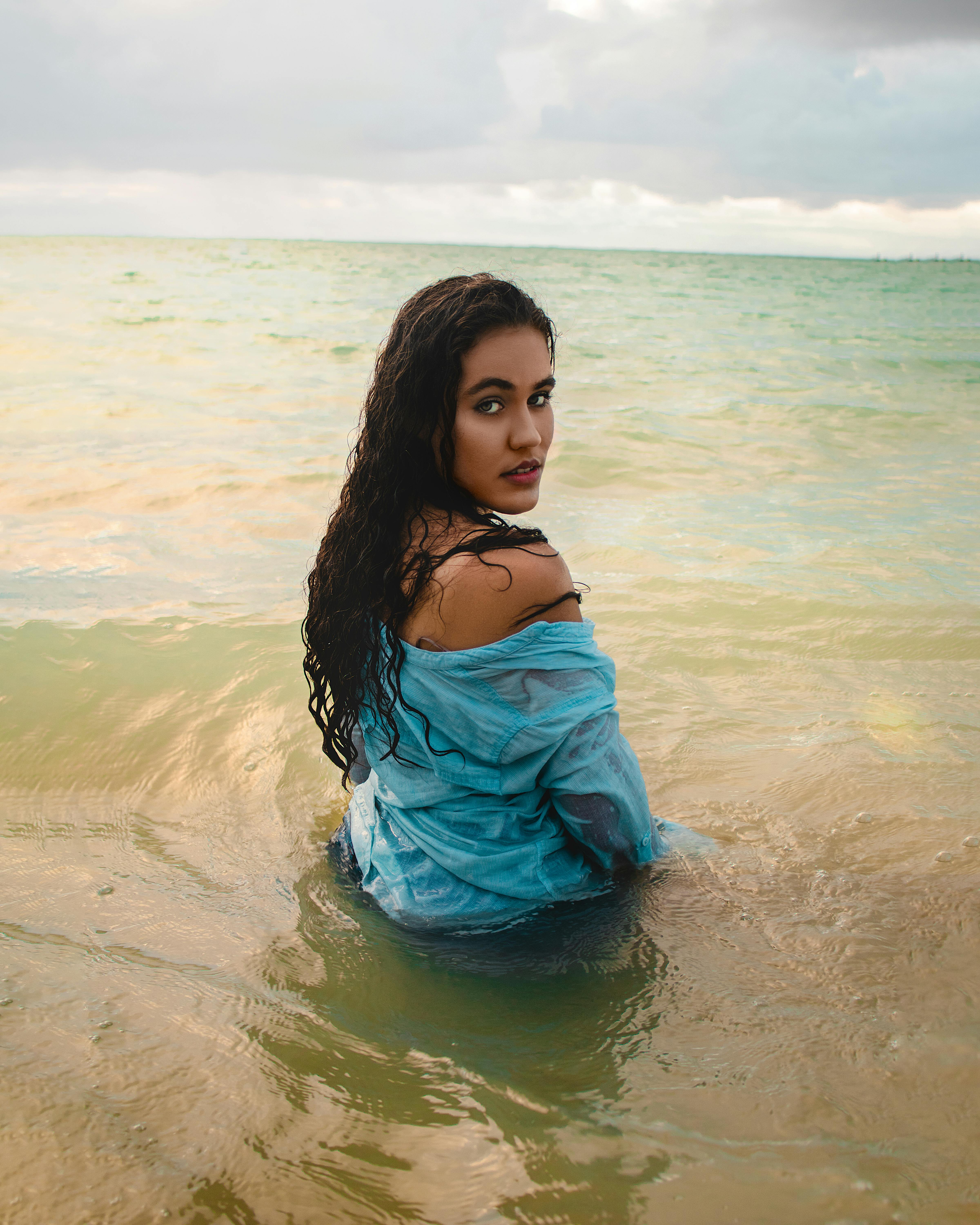 Woman Posing in Water at Sunrise · Free Stock Photo