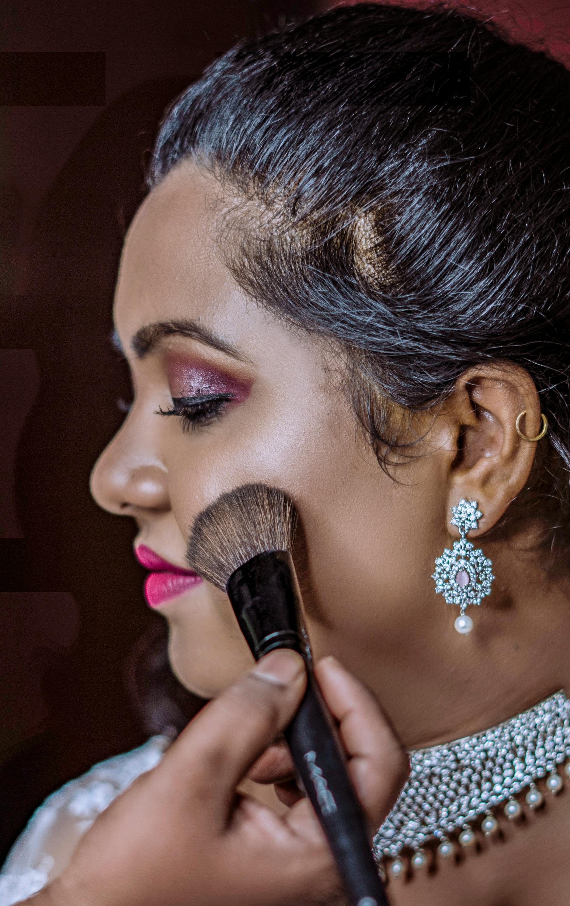 Woman Sitting on Blue and White Floral Parson's Chair Holding Makeup ...