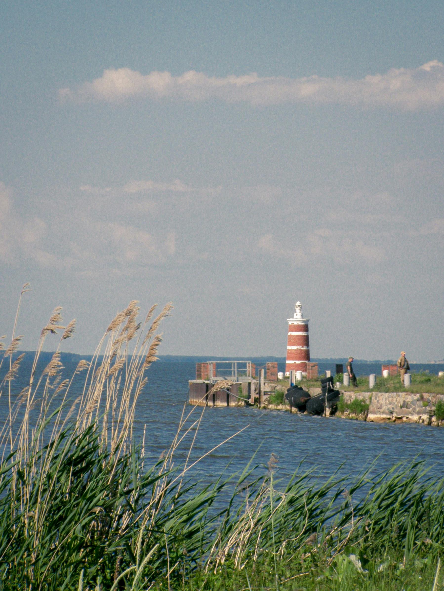 Red and White Lighthouse on Beach · Free Stock Photo