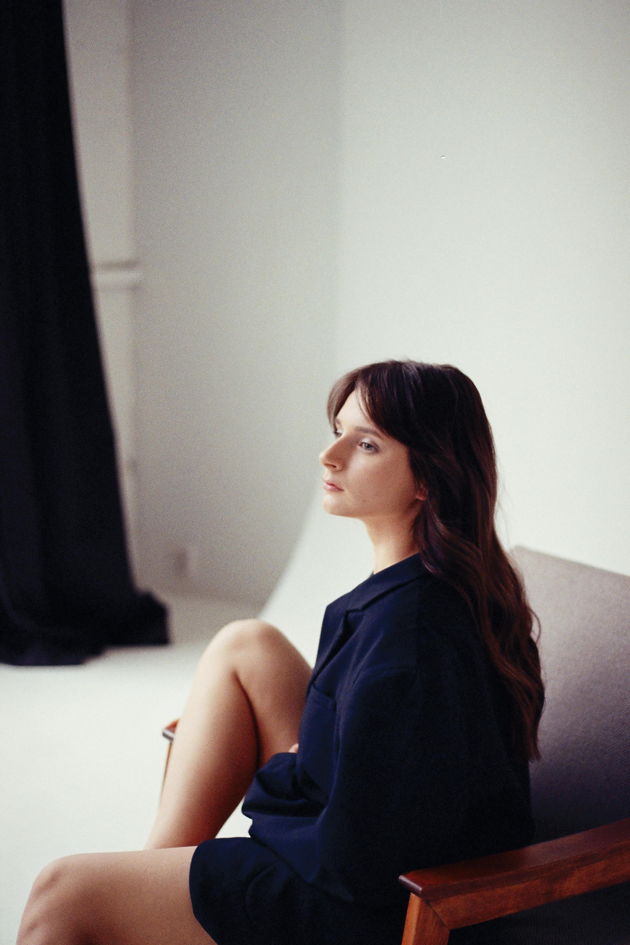 Mujer Sentada En Un Sillón En Una Habitación · Foto de stock gratuita