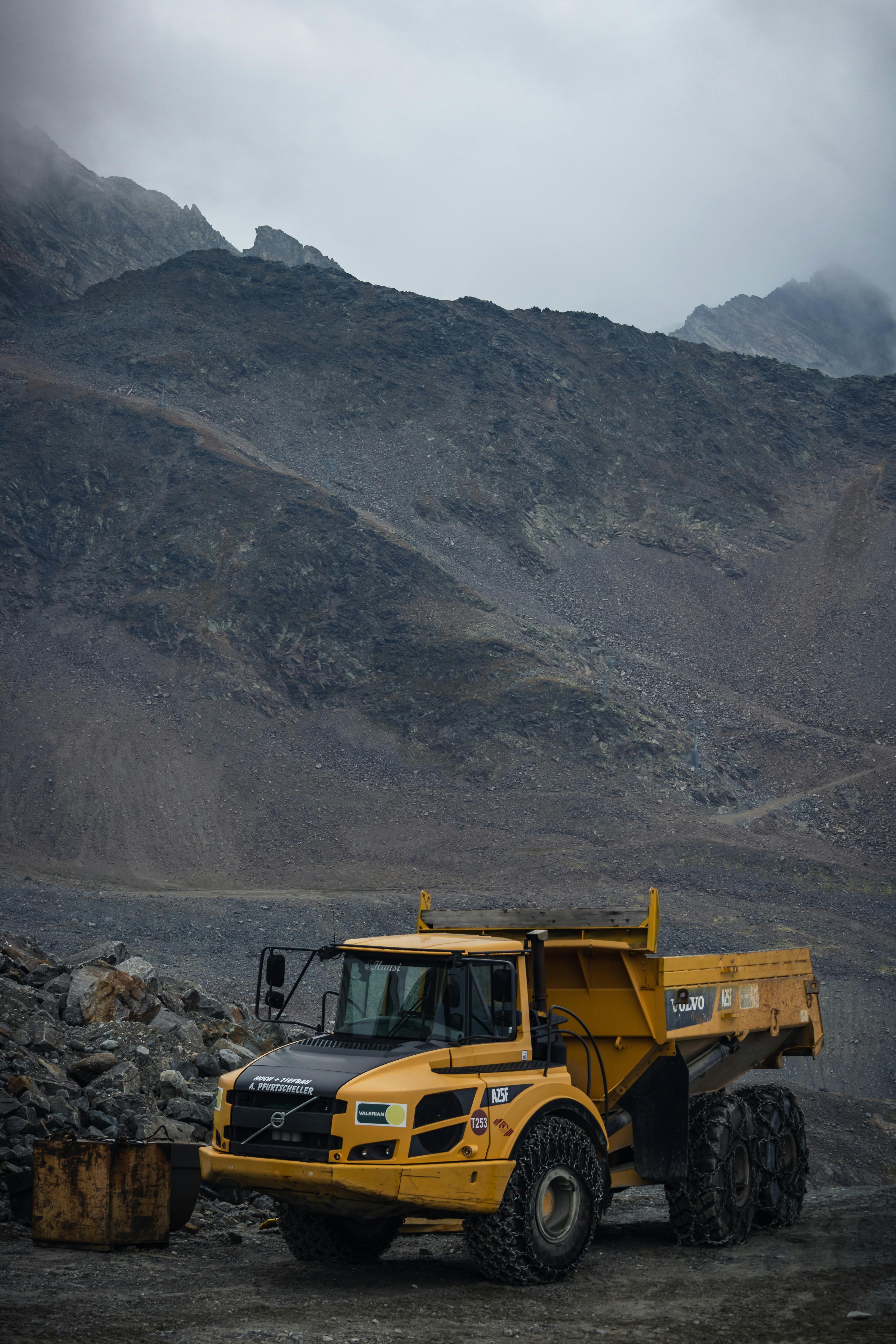 Yellow Heavy Equipment Near Gray Mountain · Free Stock Photo