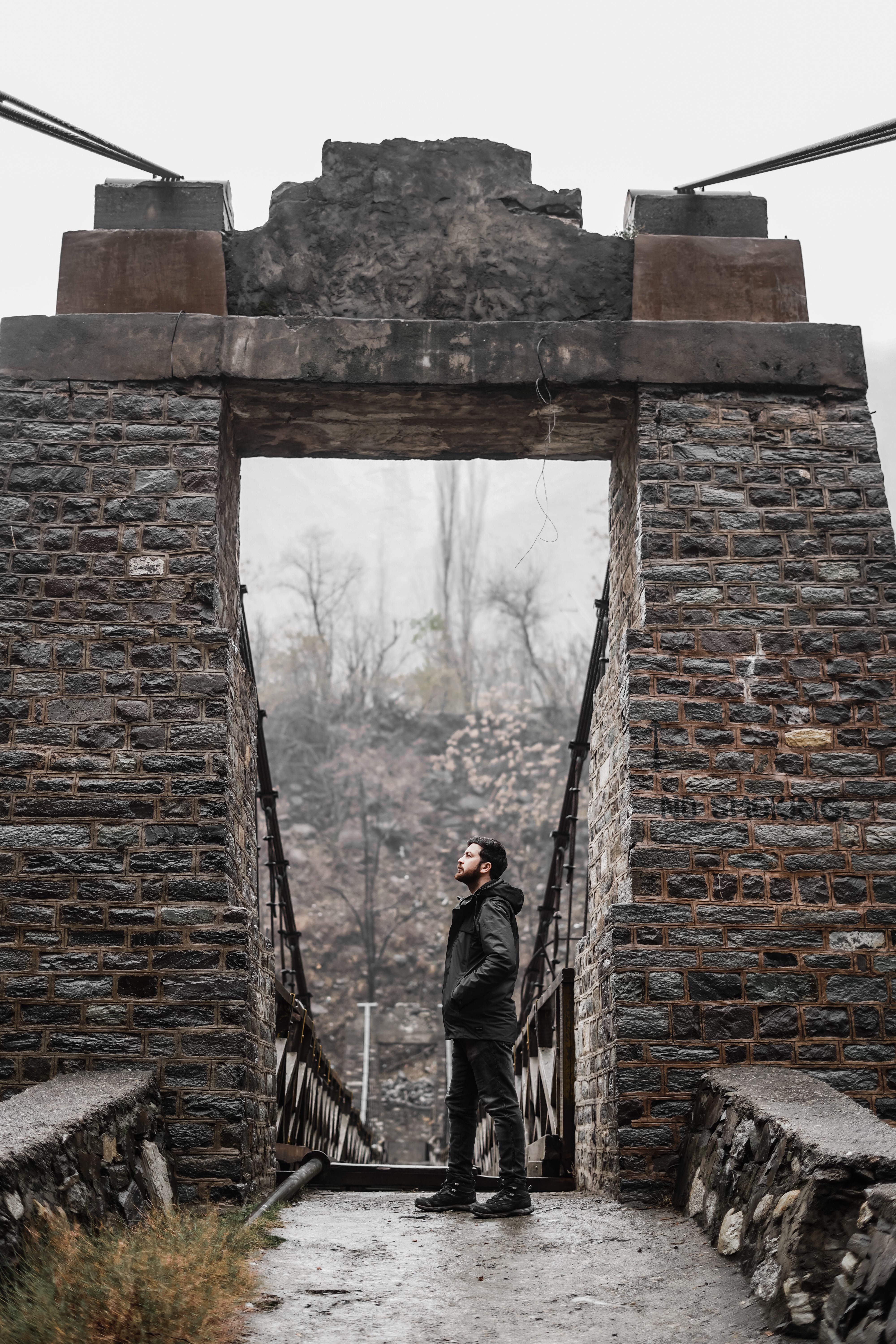 Man Standing in Stone Gate · Free Stock Photo