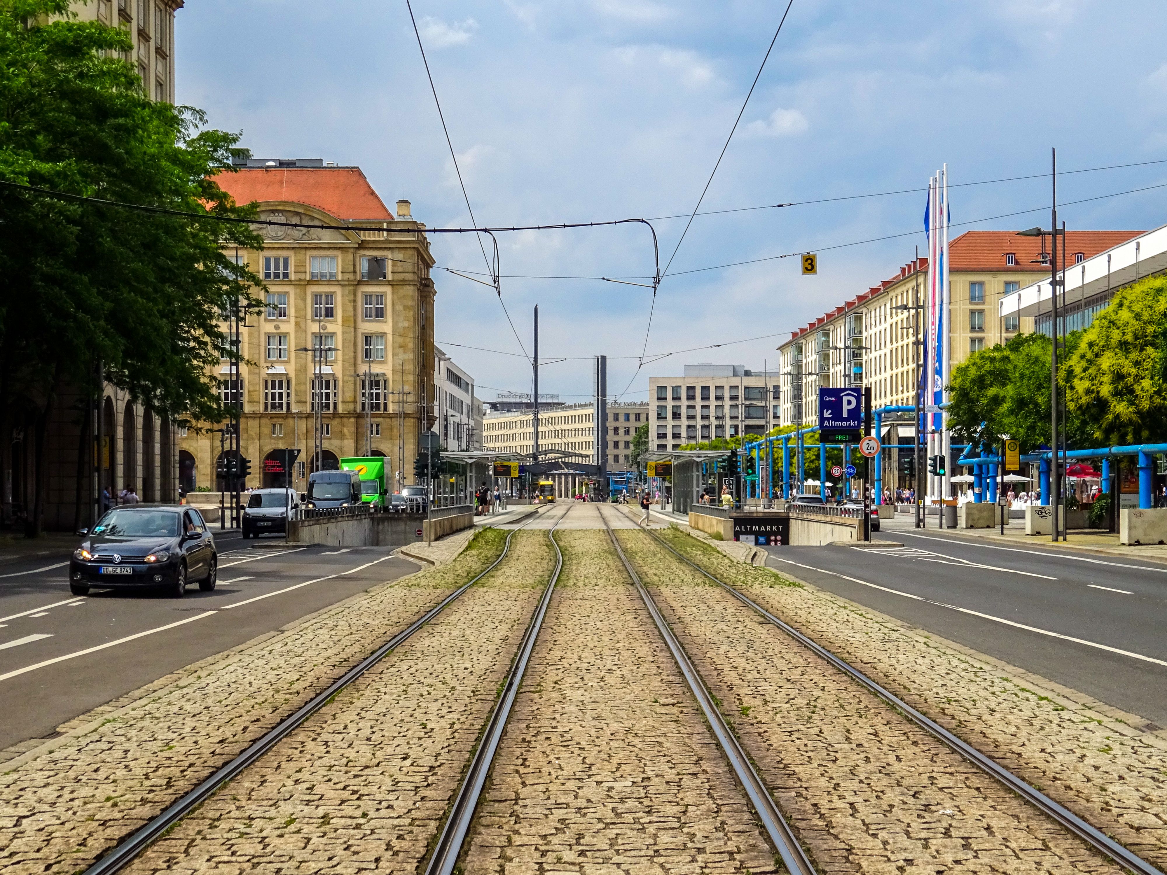 A Tram in the Middle of the Road Near Buildings · Free Stock Photo