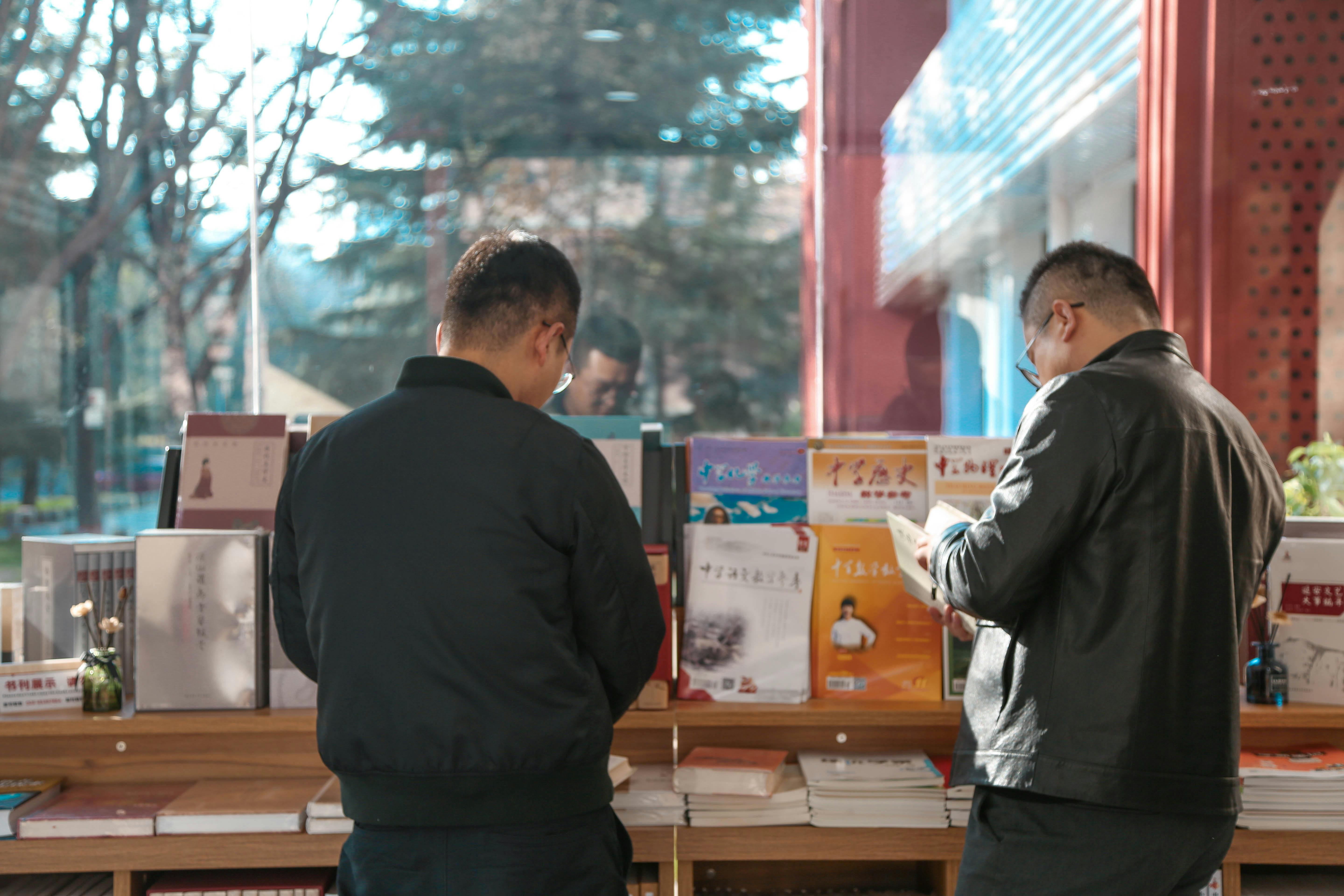 Person Reading A Book Inside A Bookstore · Free Stock Photo