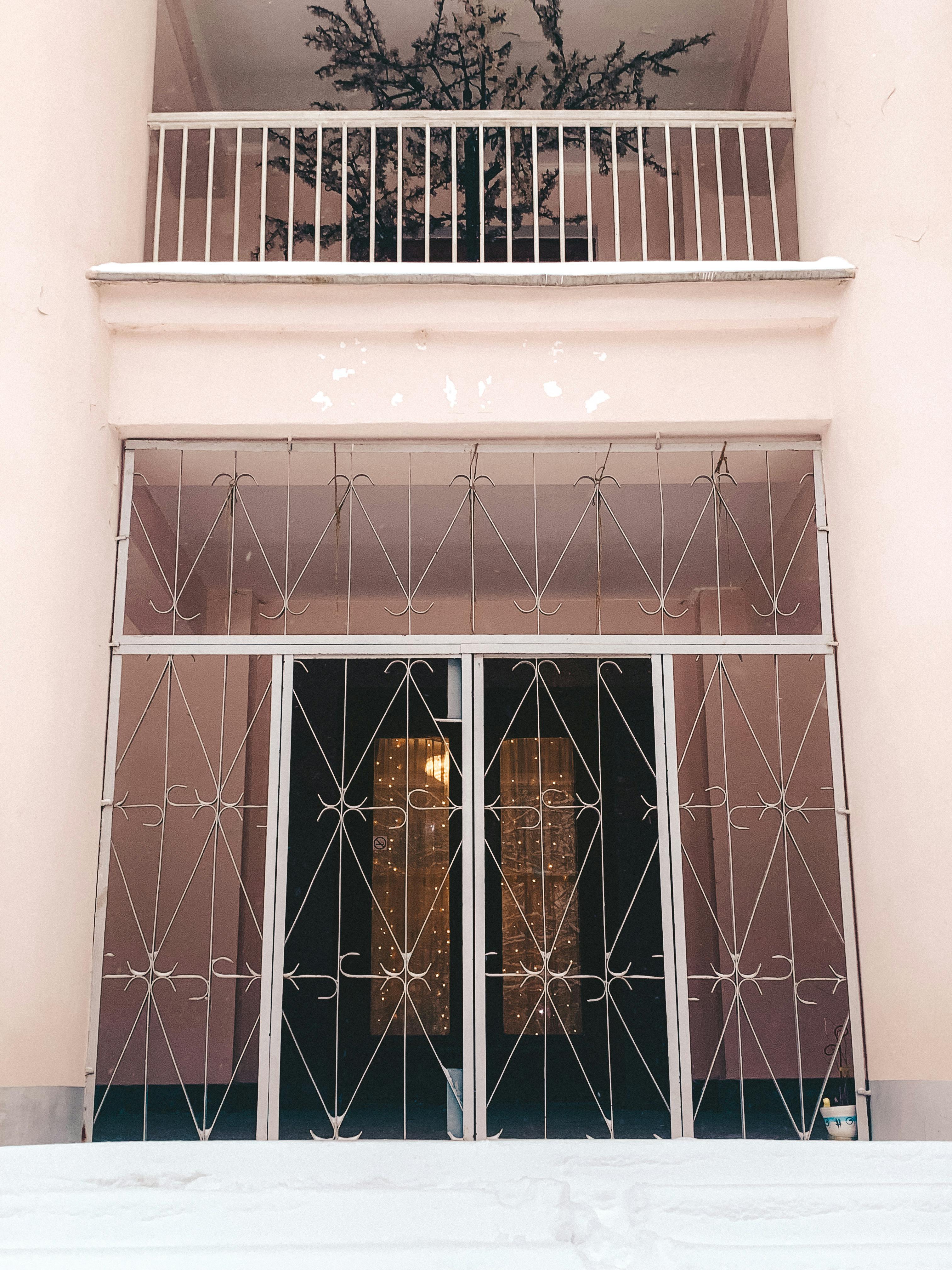 White Metal Gate on White Wall · Free Stock Photo