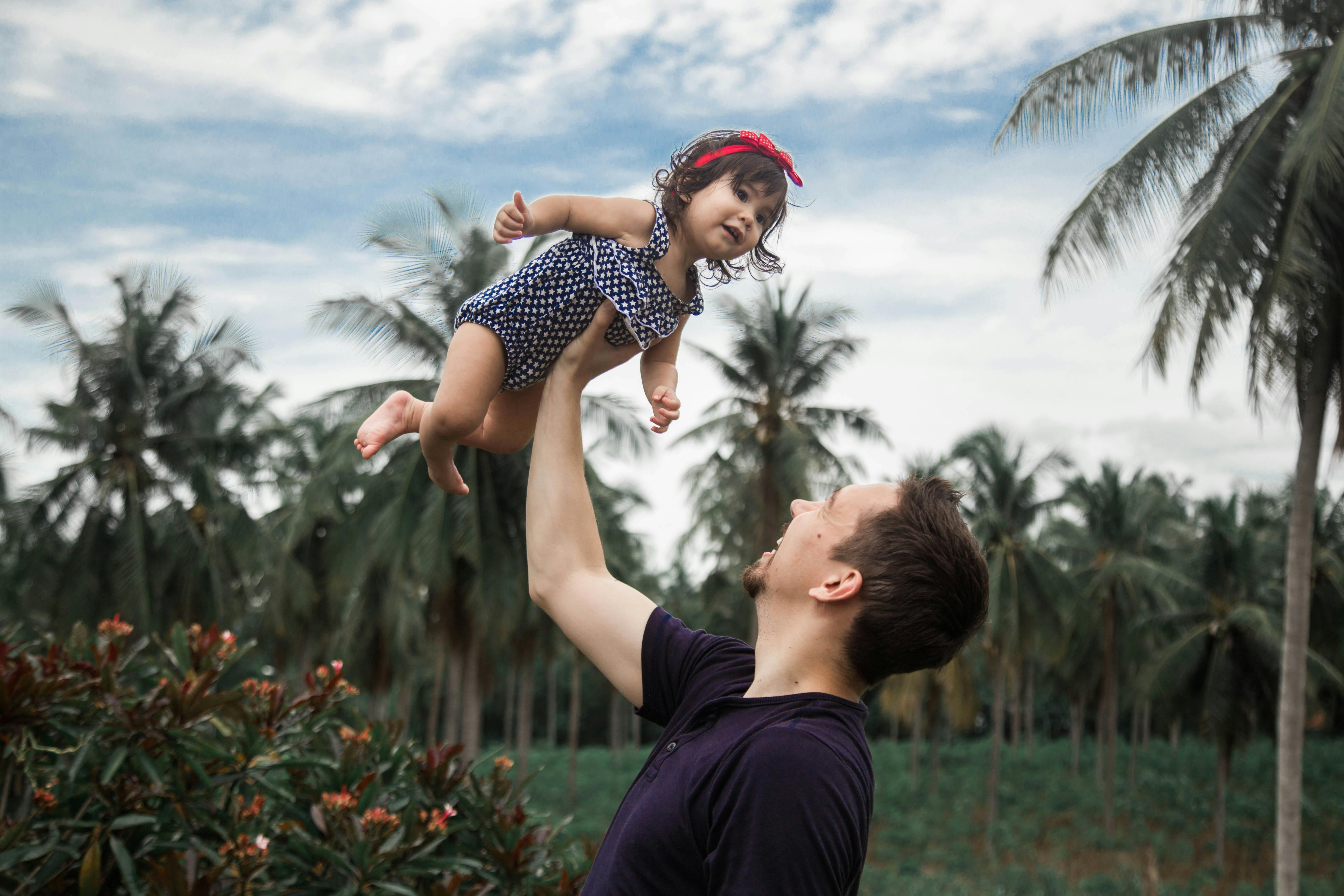 Man Carrying an Adorable Baby · Free Stock Photo