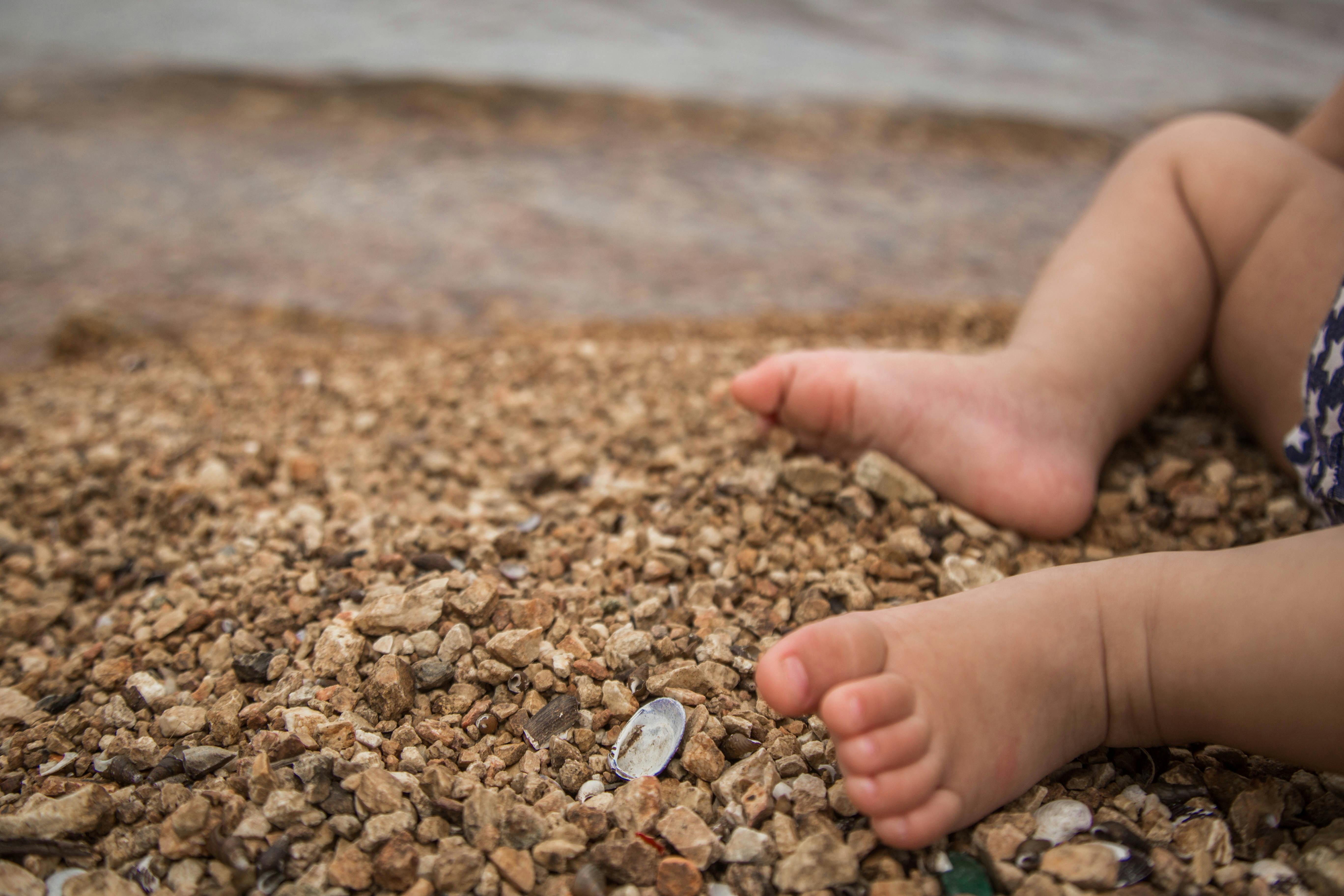 Child's Feet on Stones · Free Stock Photo