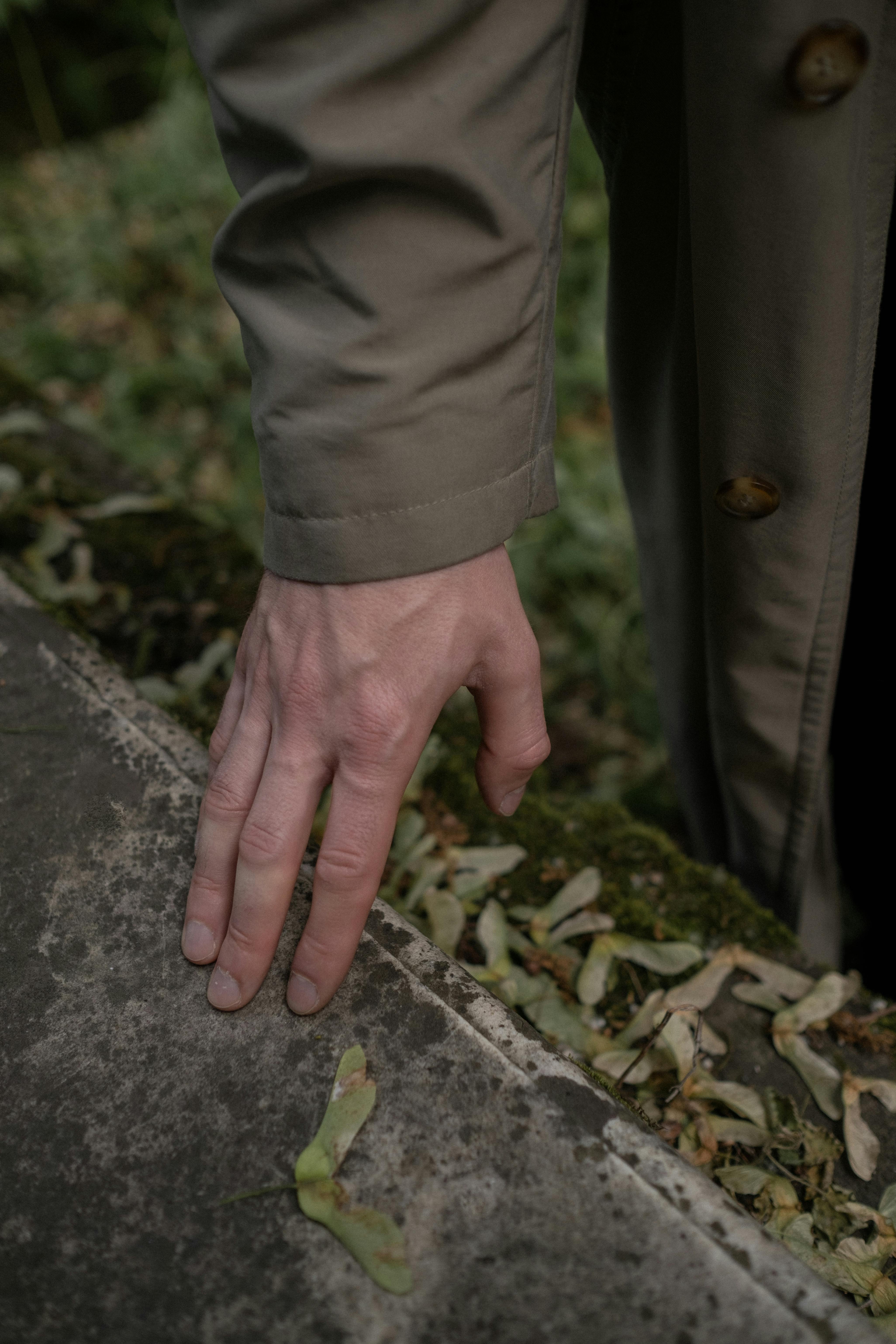 A Person Touching a Grave Stone · Free Stock Photo