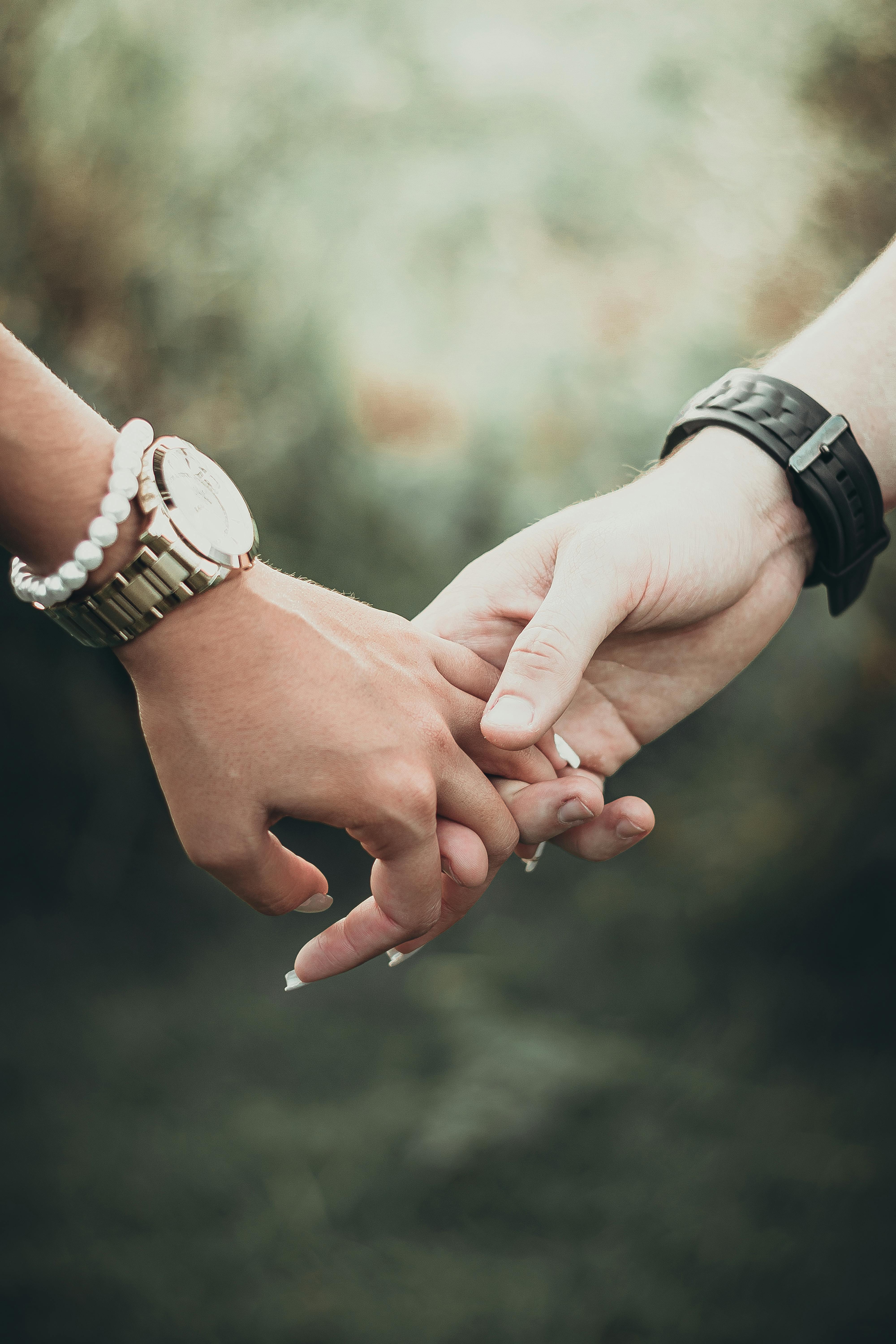 close-Up Photo of Two Person's Holding Hands · Free Stock Photo