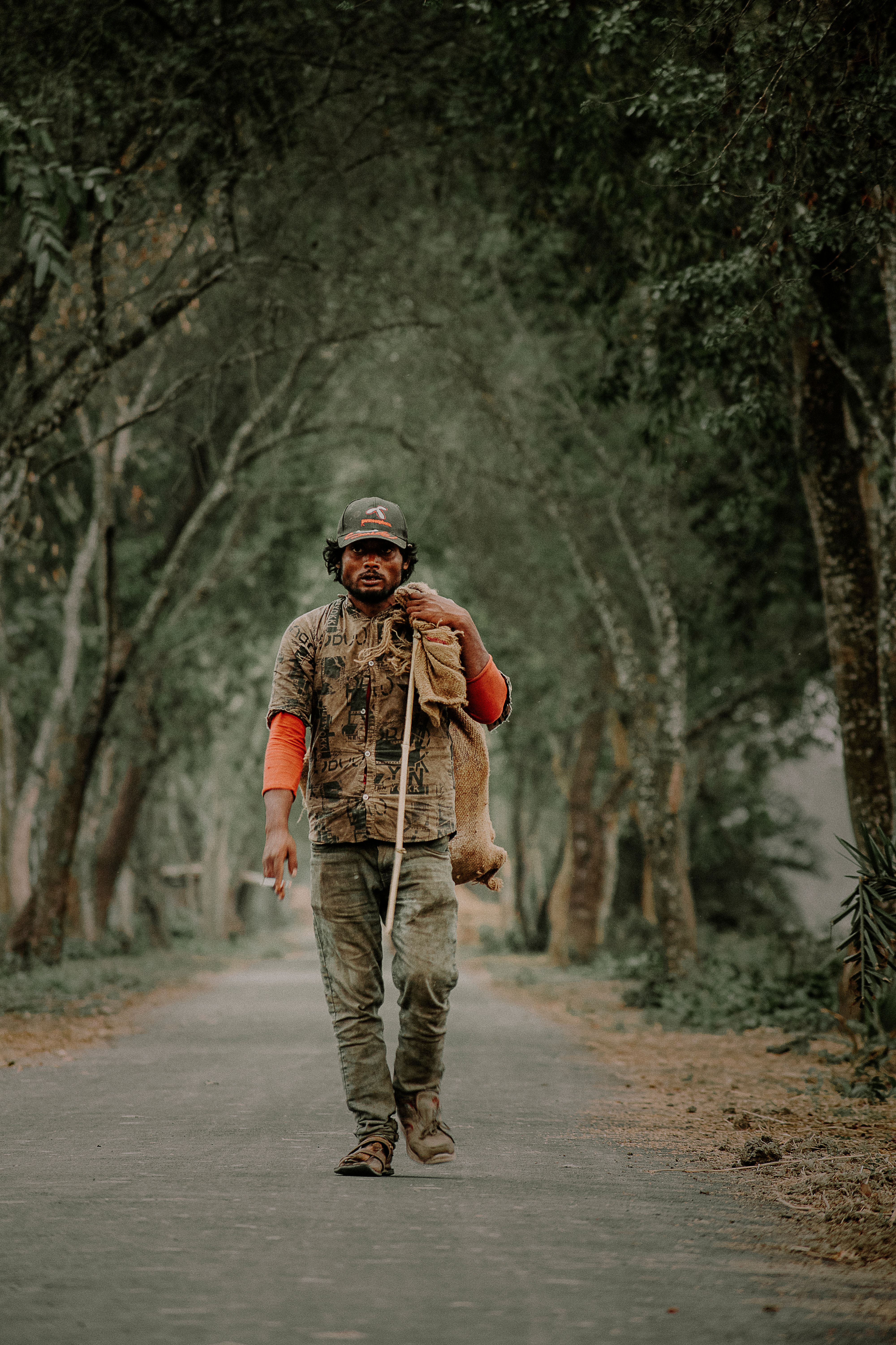 A Man Walking Carrying a Sack · Free Stock Photo