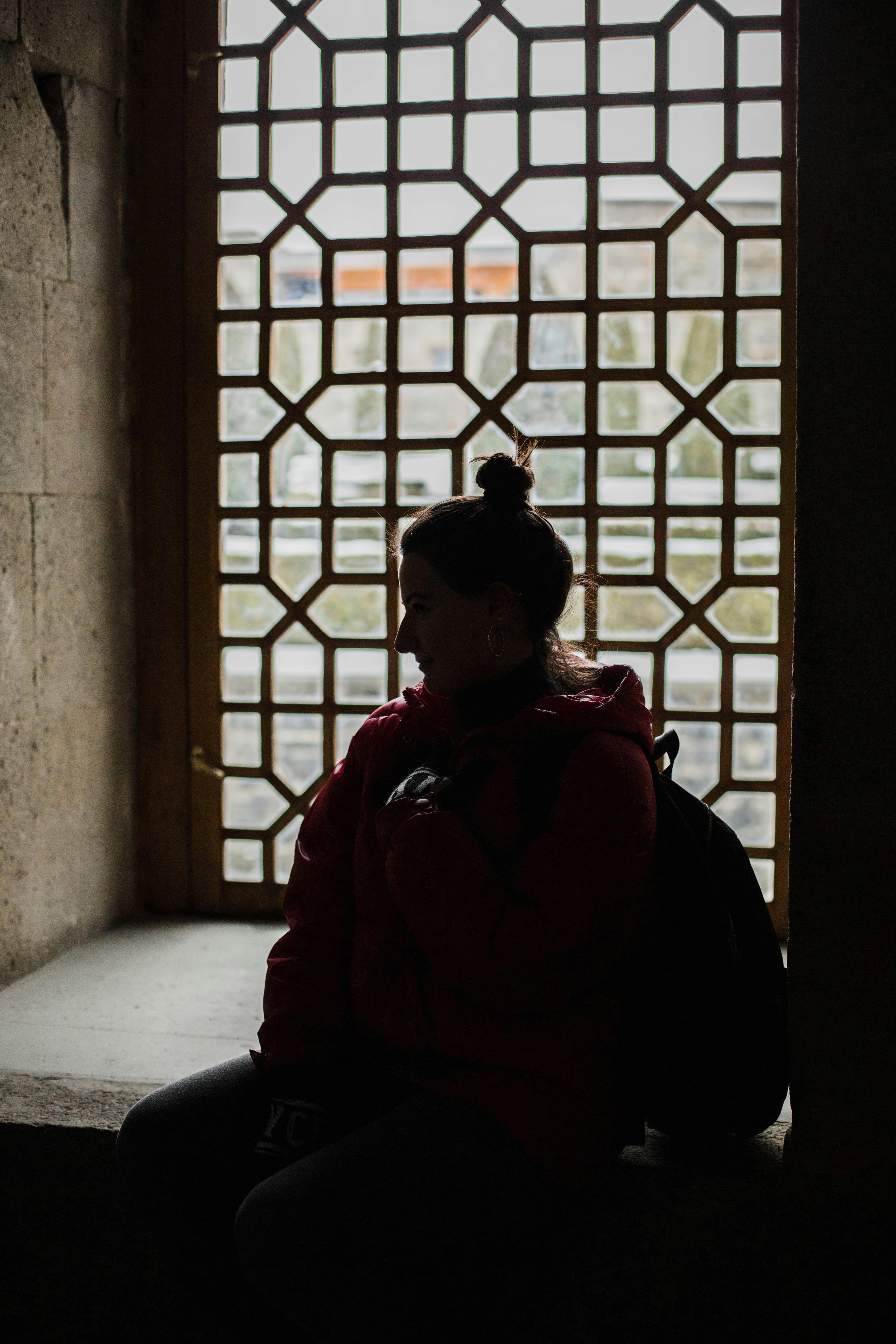 Photo of a Woman Posing Near Window Shutters · Free Stock Photo