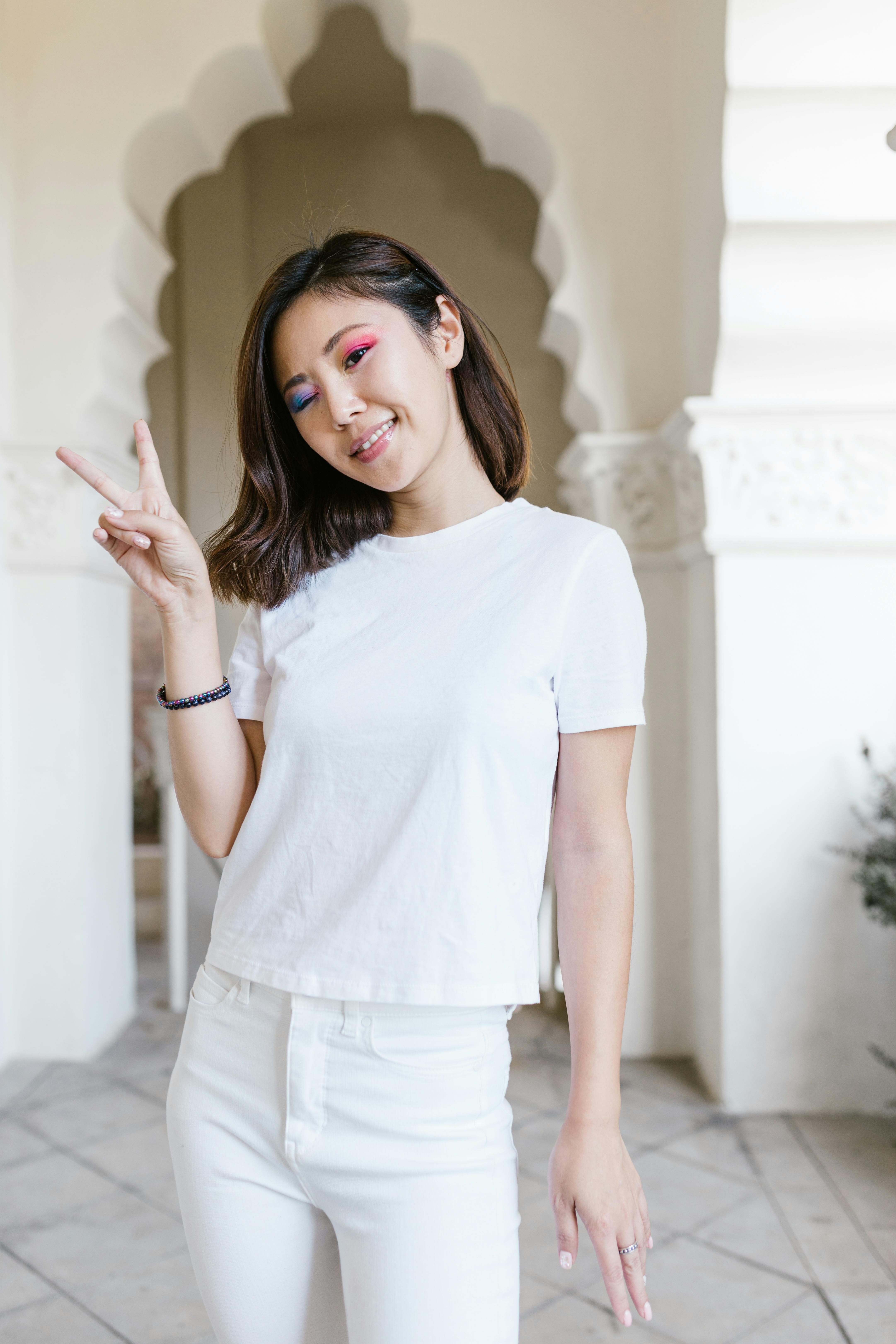 Woman Winking and Doing Peace Sign · Free Stock Photo