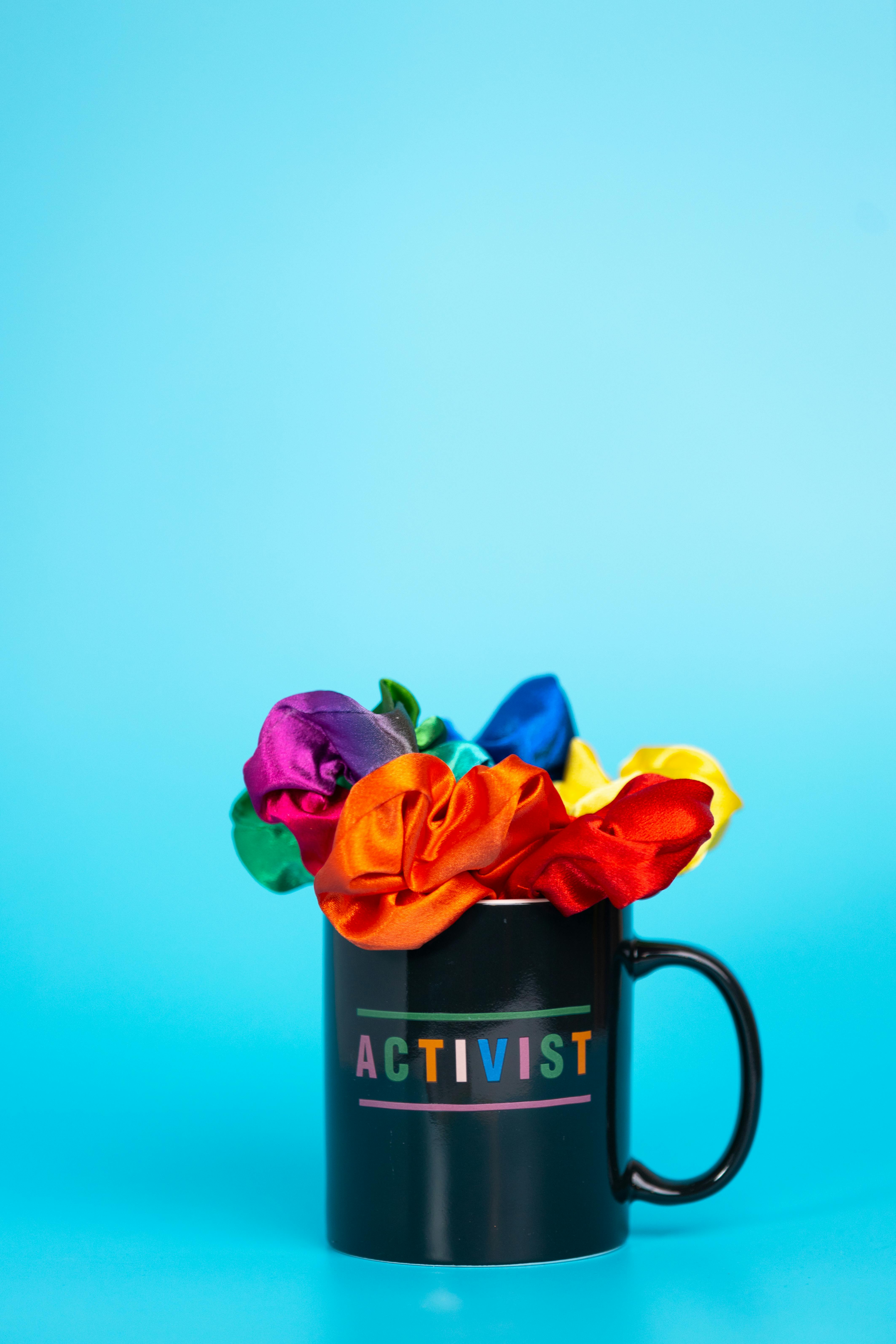 Blue Mug with Slogan of Equity and Rainbow Cloth · Free Stock Photo