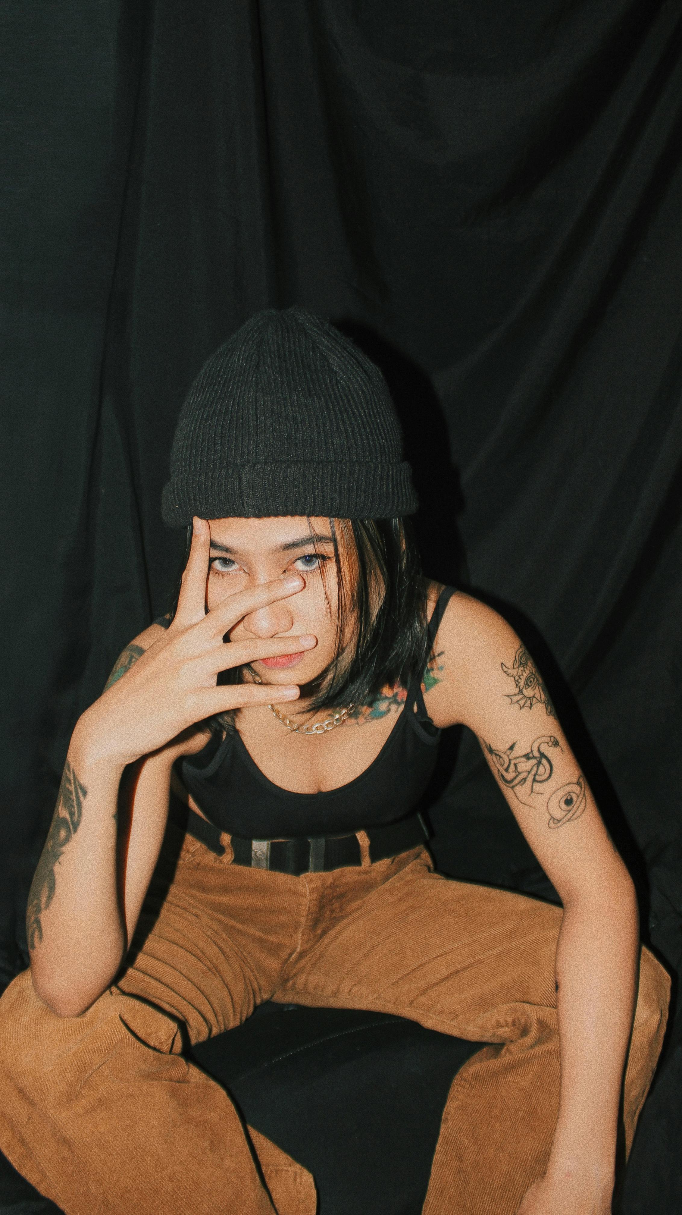 A Tattooed Man Wearing Black Tank Top · Free Stock Photo