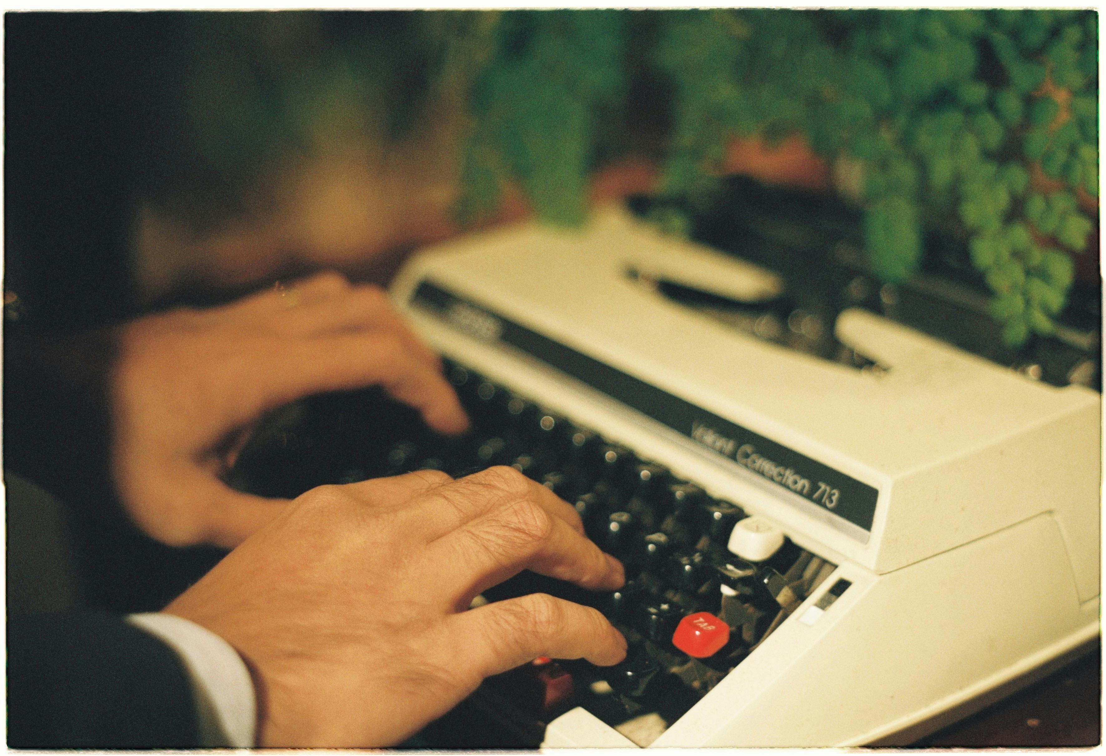 A Person Using a Typewriter · Free Stock Photo