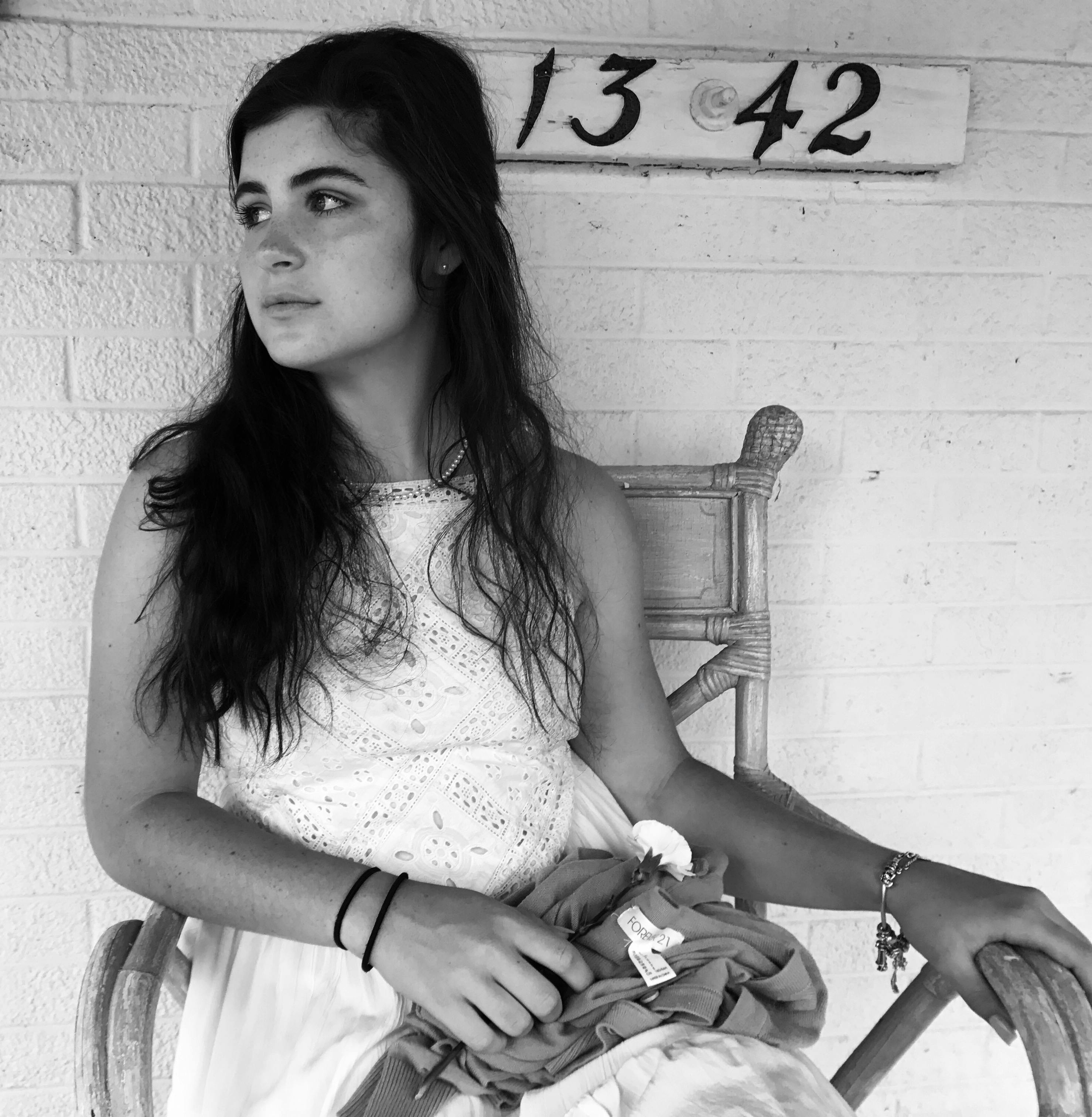 Grayscale Photo of Girl Sitting on Armchair · Free Stock Photo