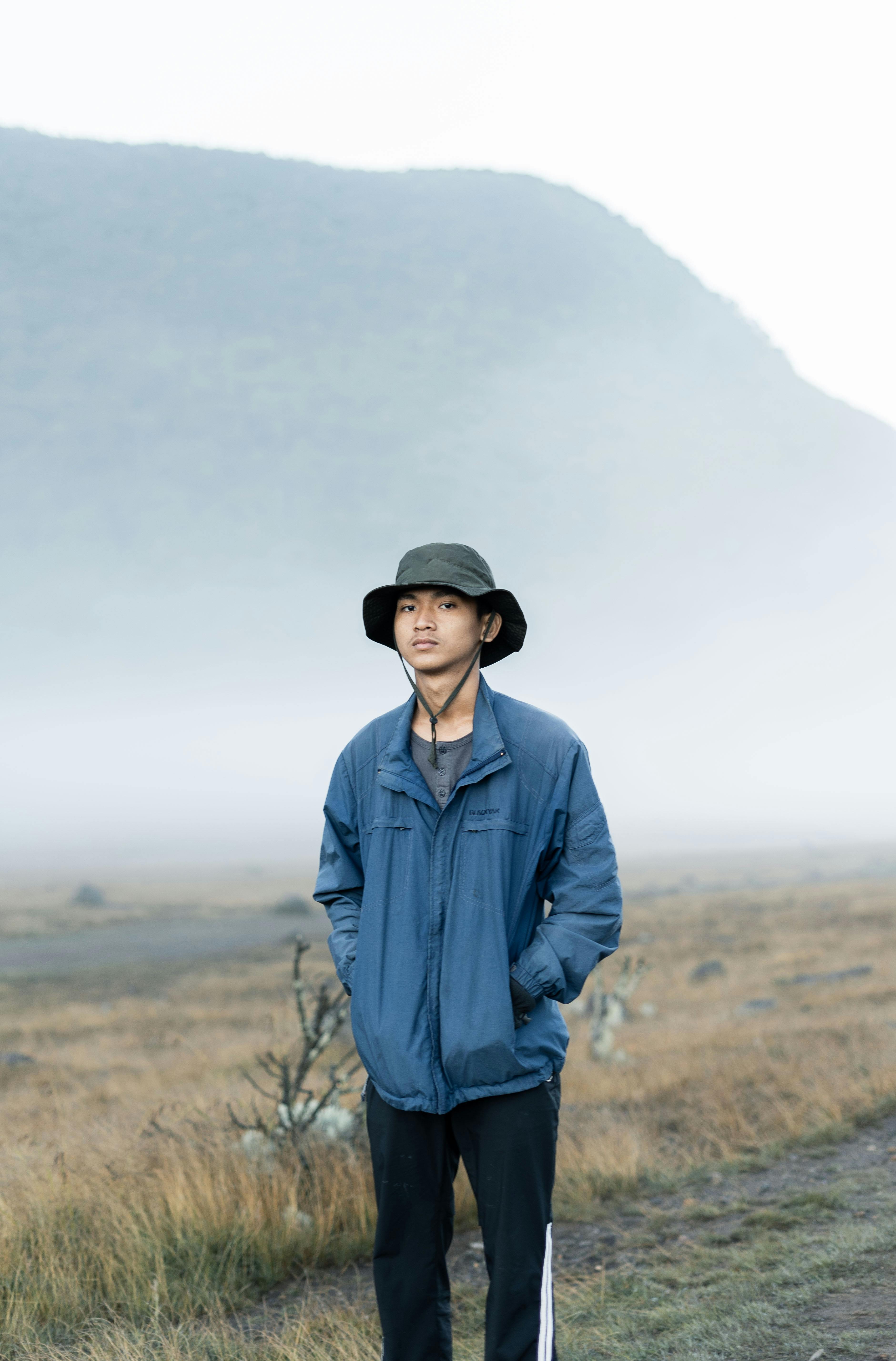 A Man Wearing a Blue Jacket with Hands inside Pockets · Free Stock Photo
