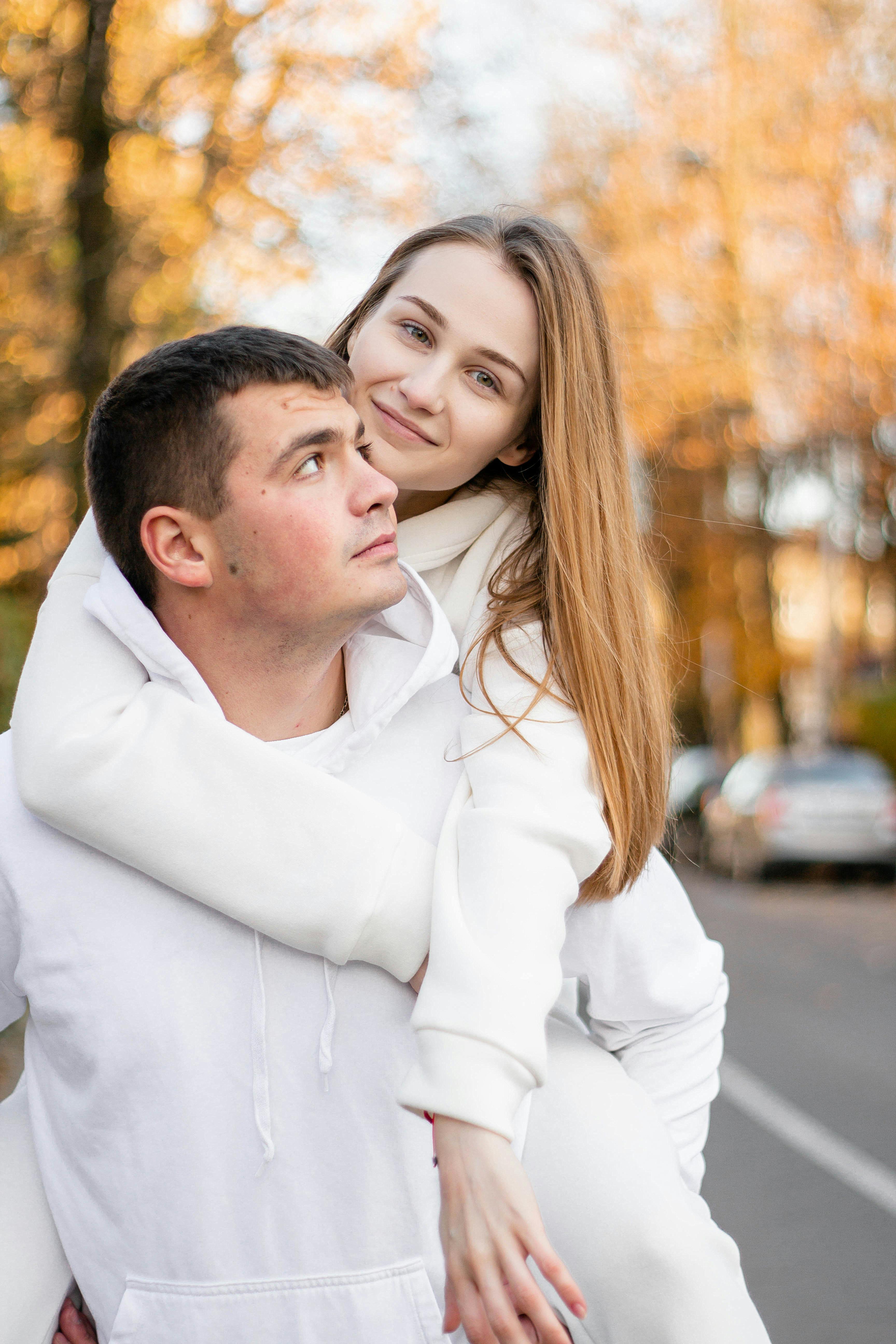 A Man Carrying a Woman on His Shoulder · Free Stock Photo