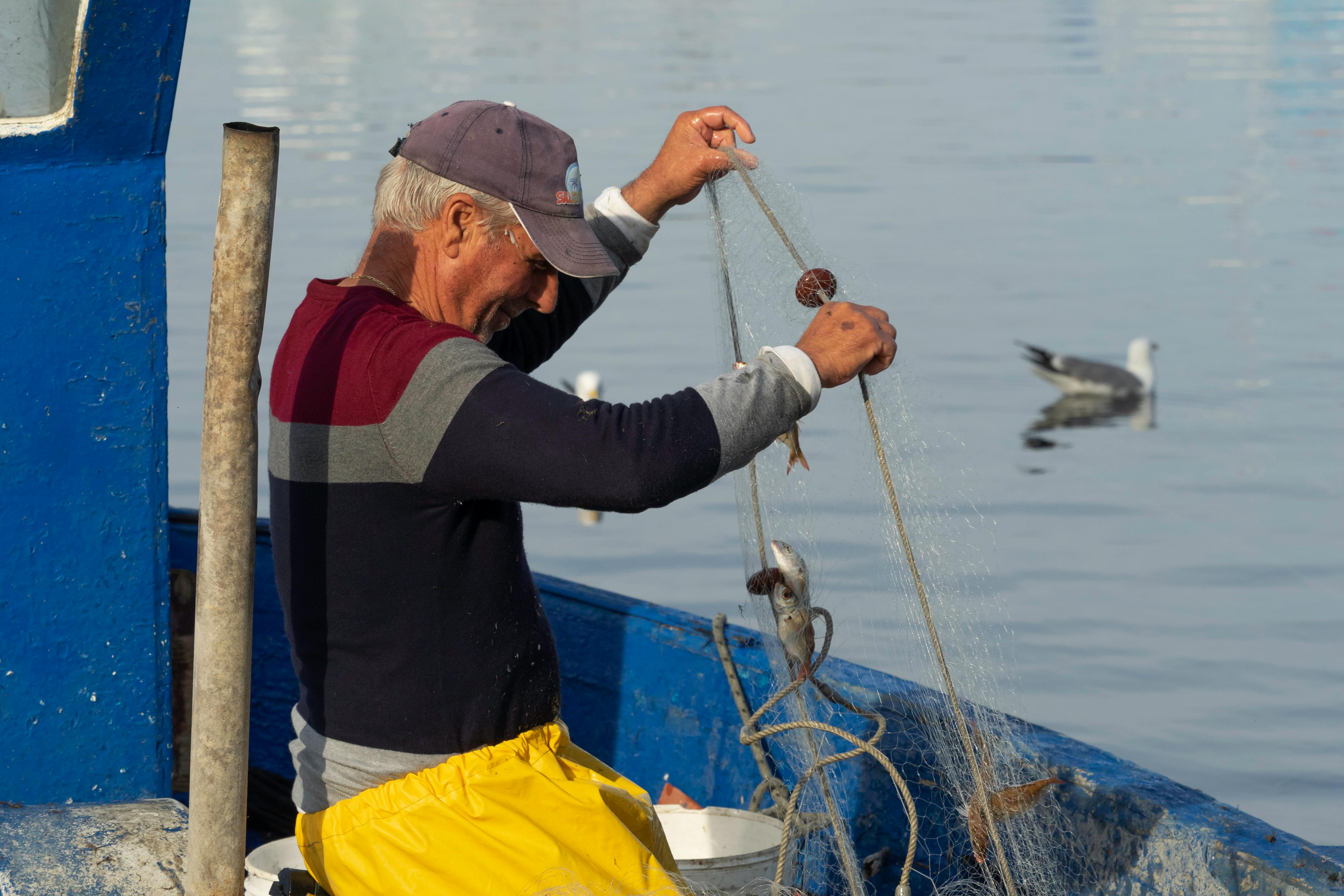 A Man Holding a Fishing Net · Free Stock Photo