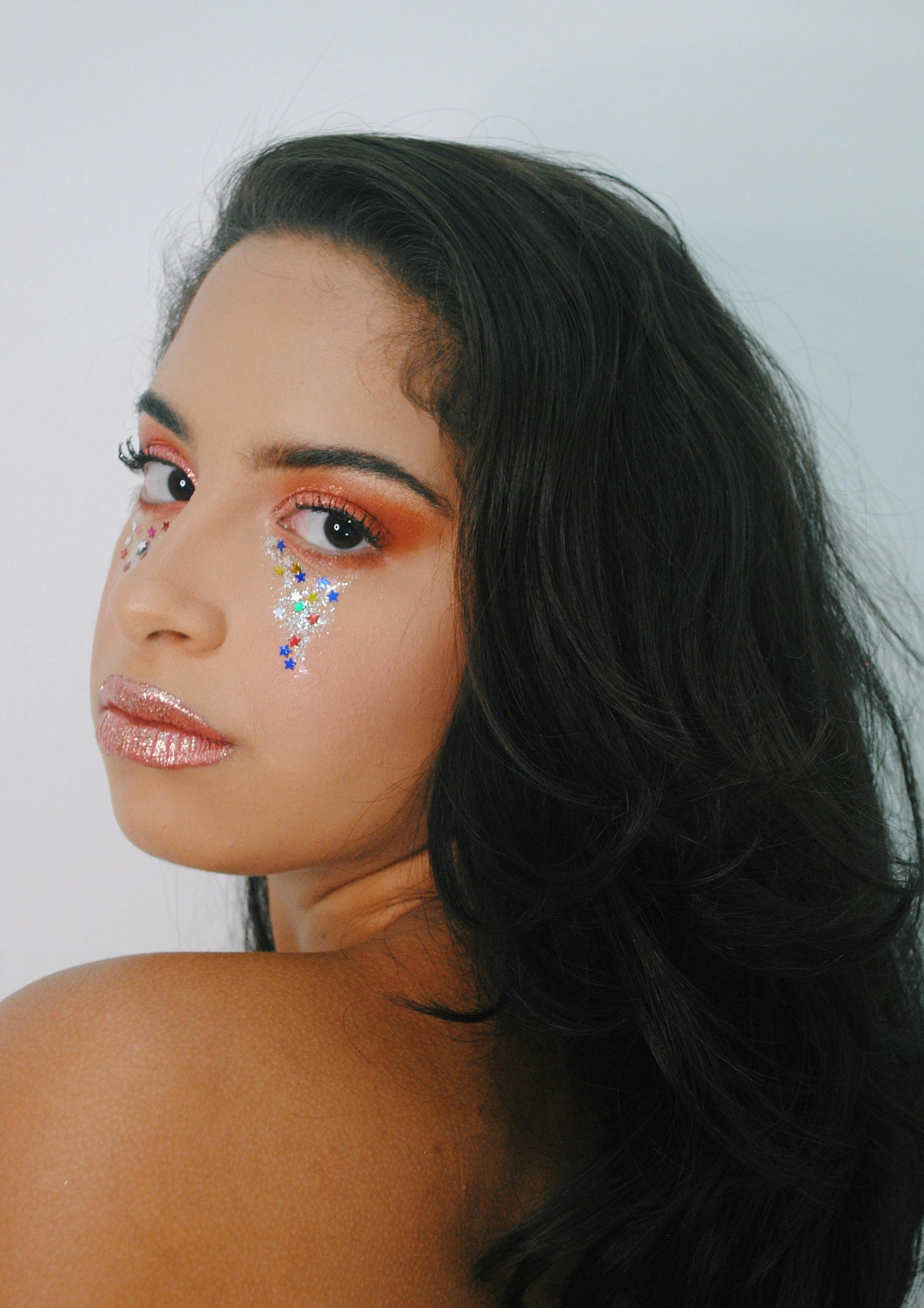 A Person Applying Eyeshadow Makeup to a Woman · Free Stock Photo