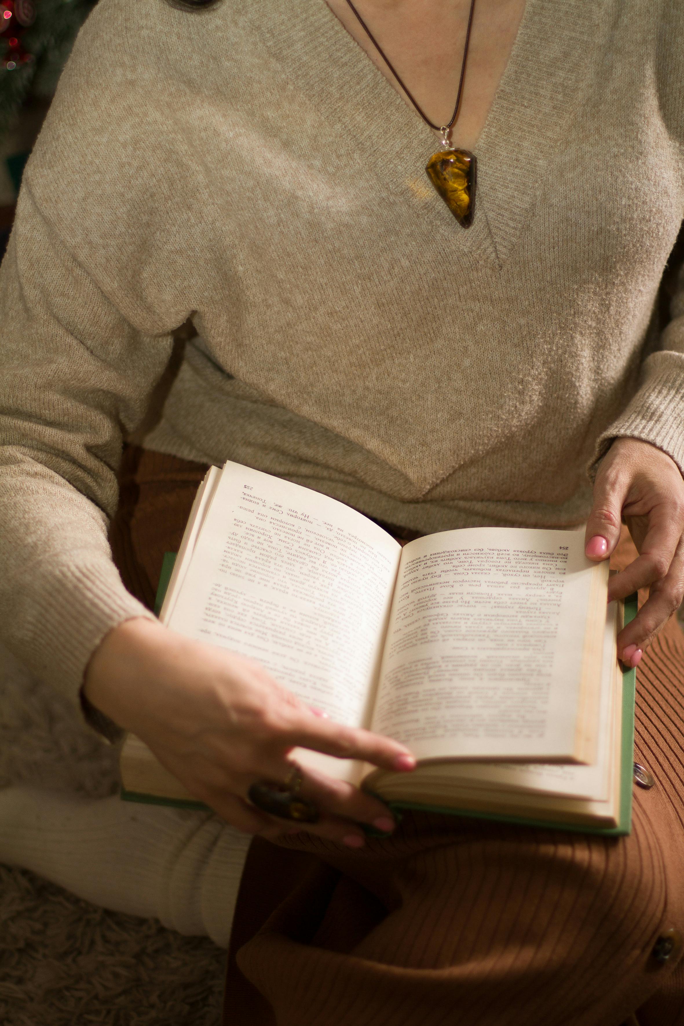 Person Holding White Book Page · Free Stock Photo