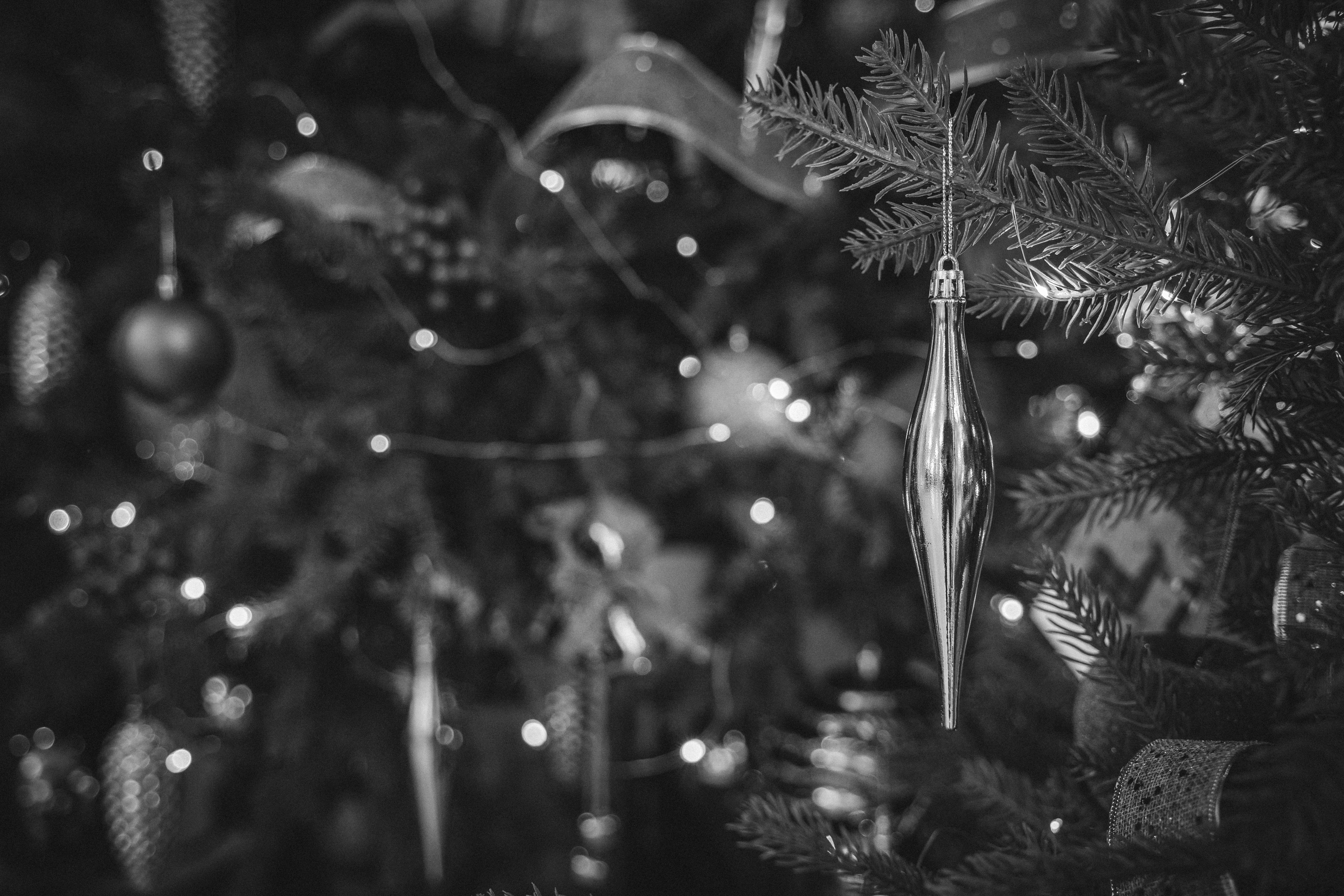 Grayscale Photo of Christmas Tree with Hanging Ornaments · Free Stock Photo