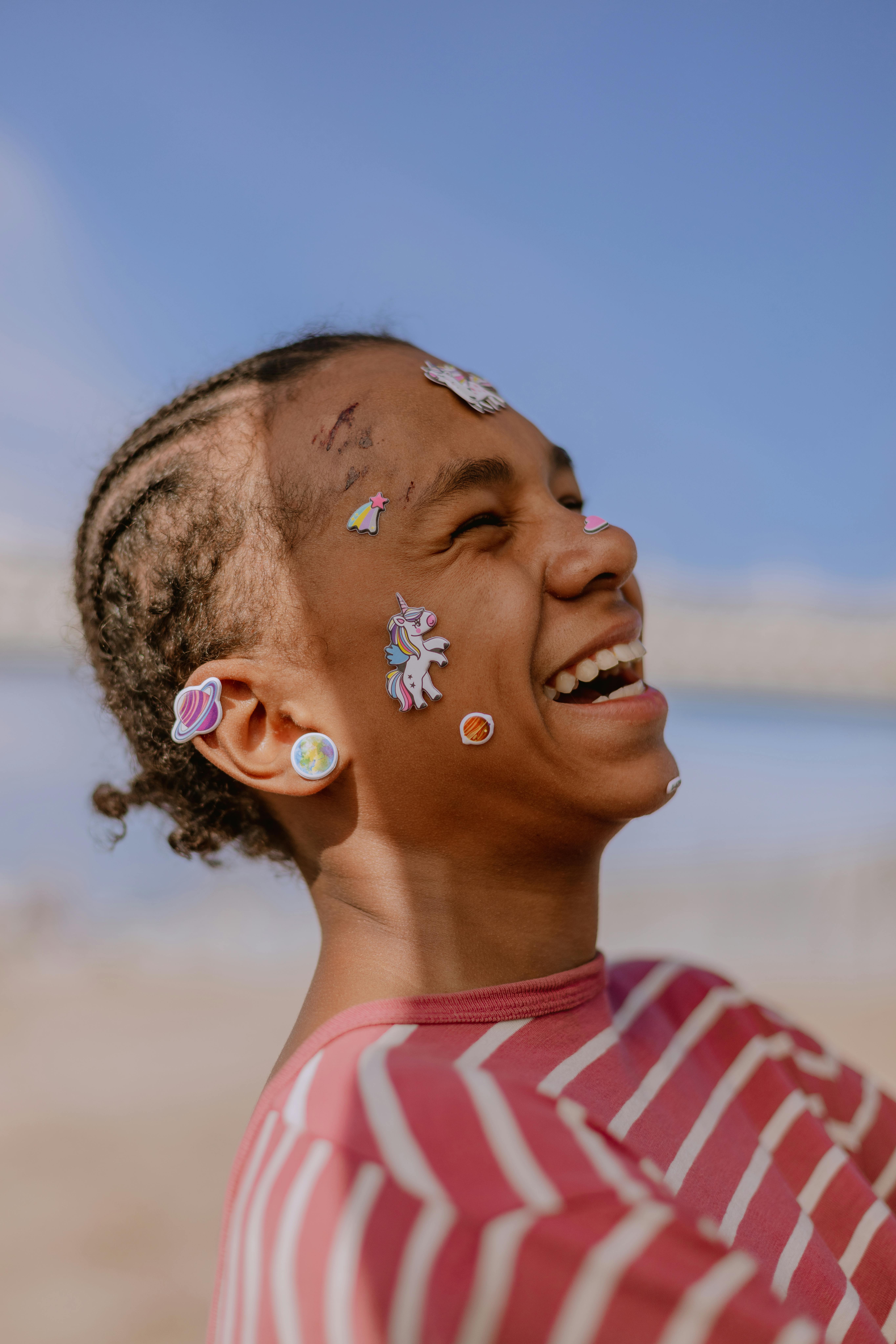 Laughing Boy with Stickers on Face · Free Stock Photo