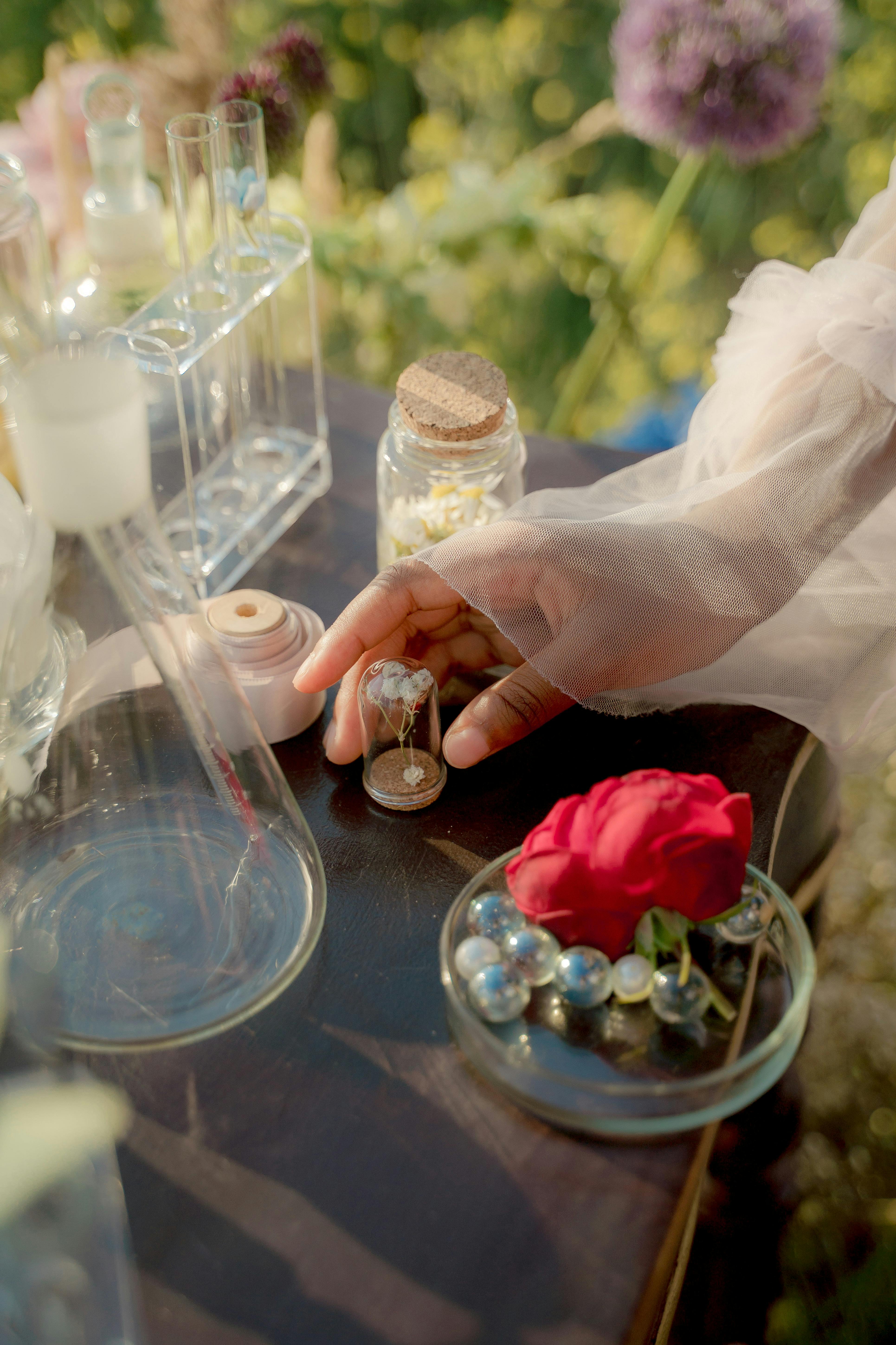 Woman Putting Flowers in Flasks · Free Stock Photo