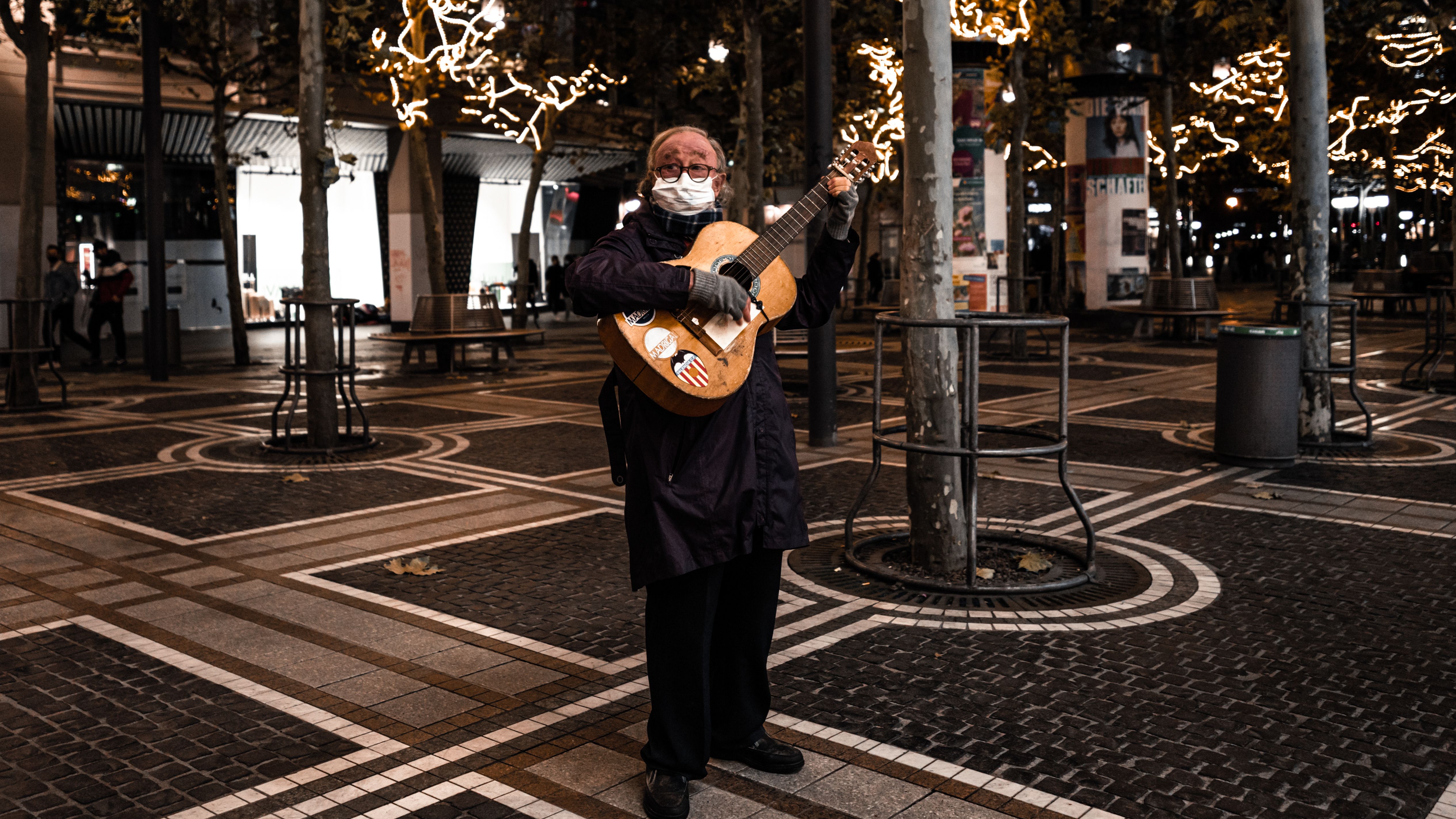 A Man in Black Suit Wearing Face Mask Playing Guitar · Free Stock Photo