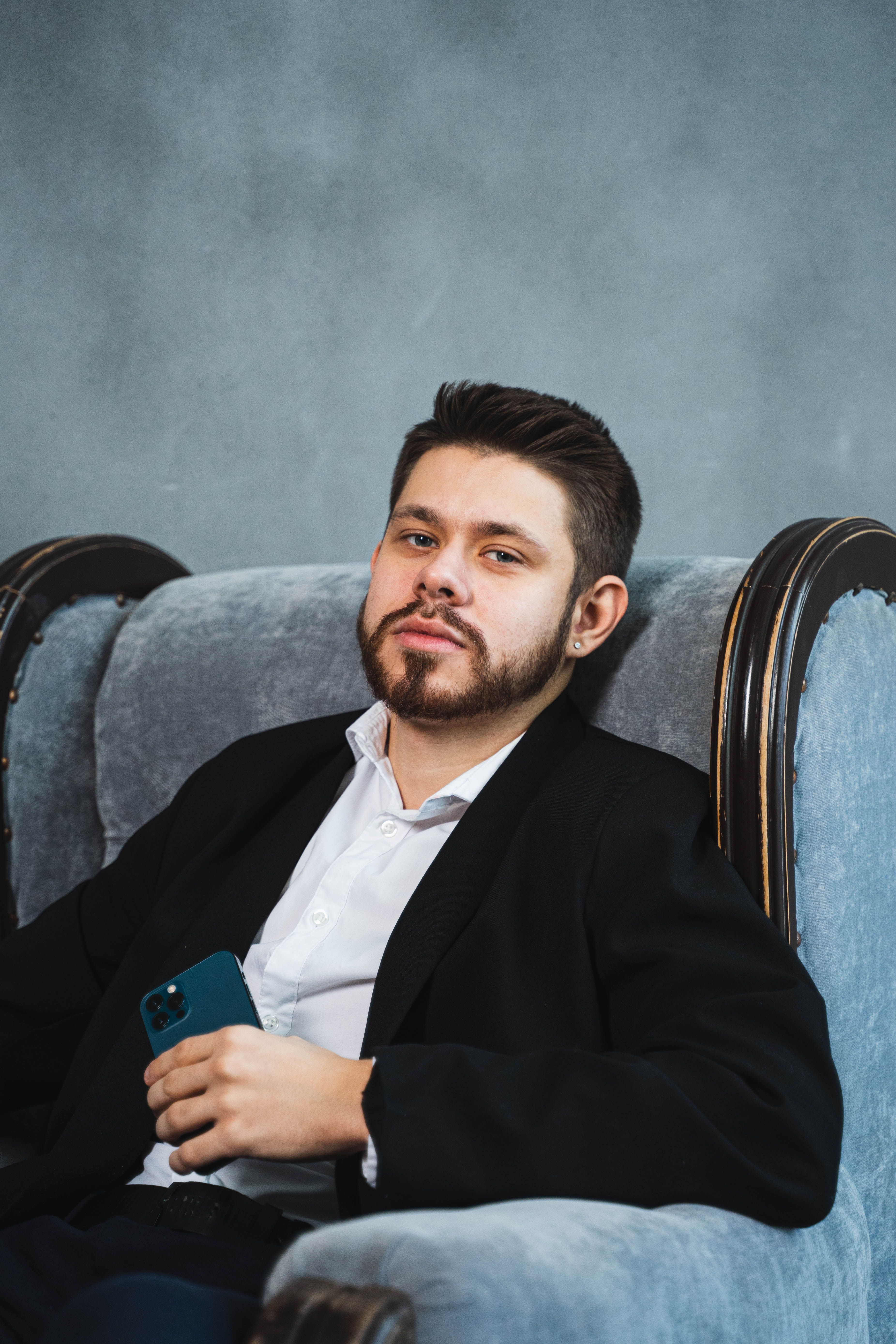 Good-Looking Man in a Suit Sitting with a Camera in his Hands · Free ...