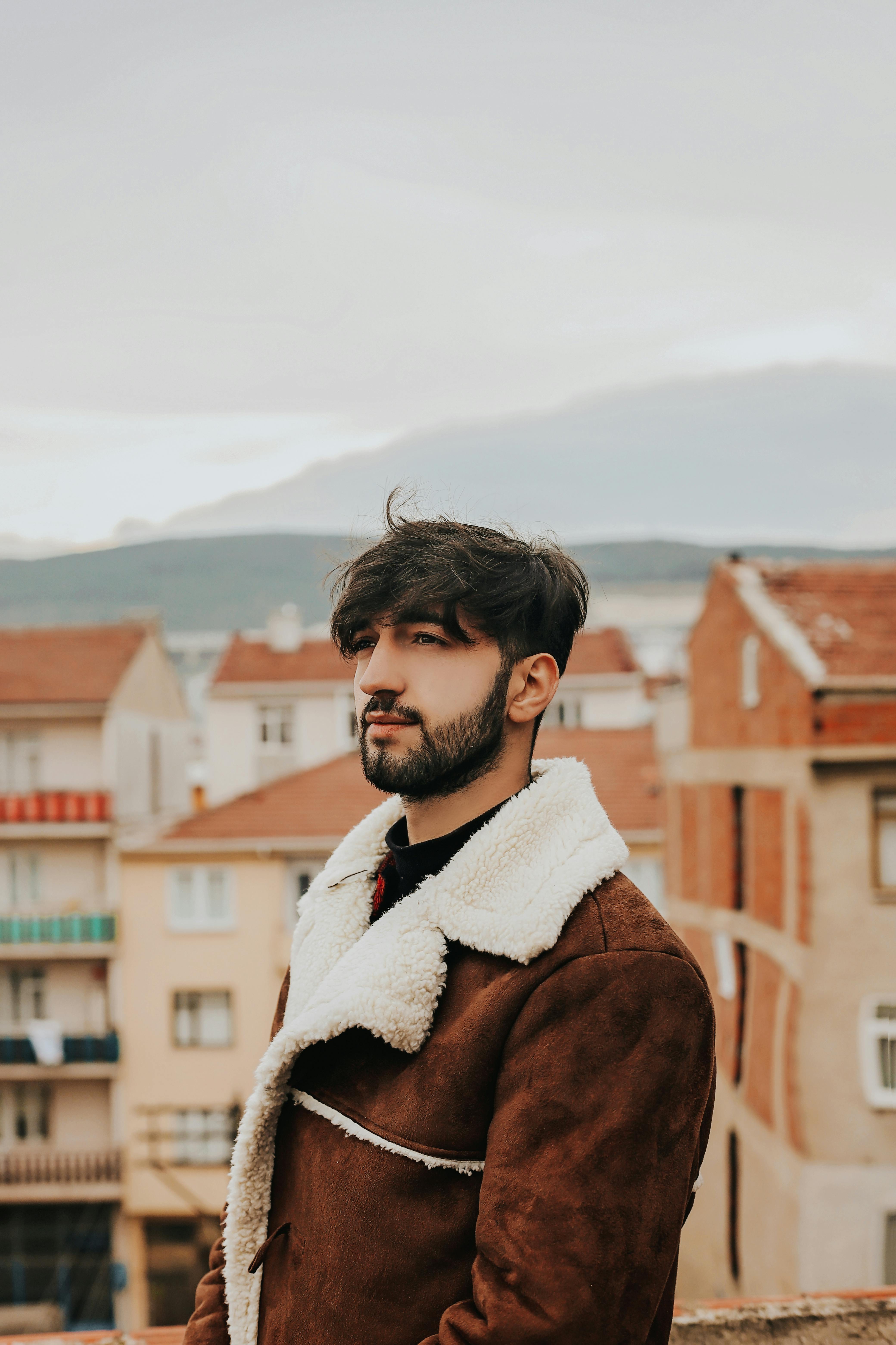 People Standing on Rooftop Looking Cityscape View · Free Stock Photo