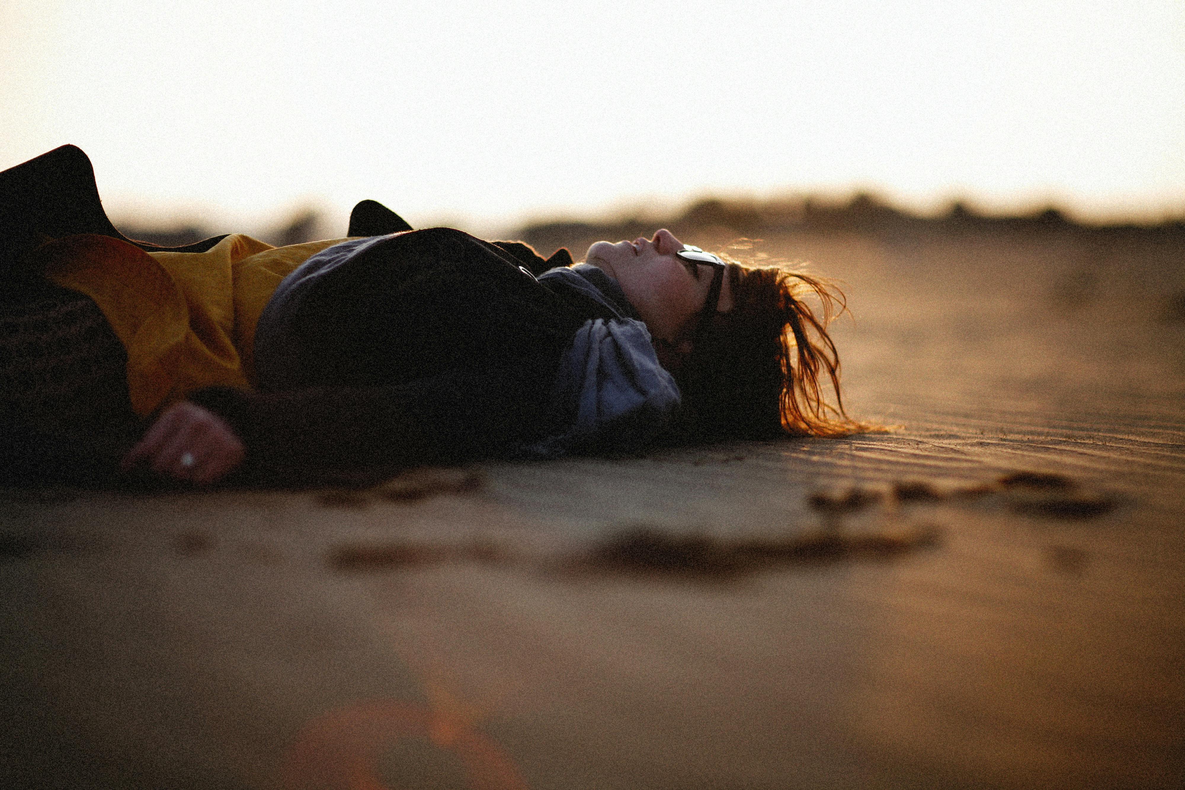 Low-Angle Shot of a Woman Lying on the Ground · Free Stock Photo