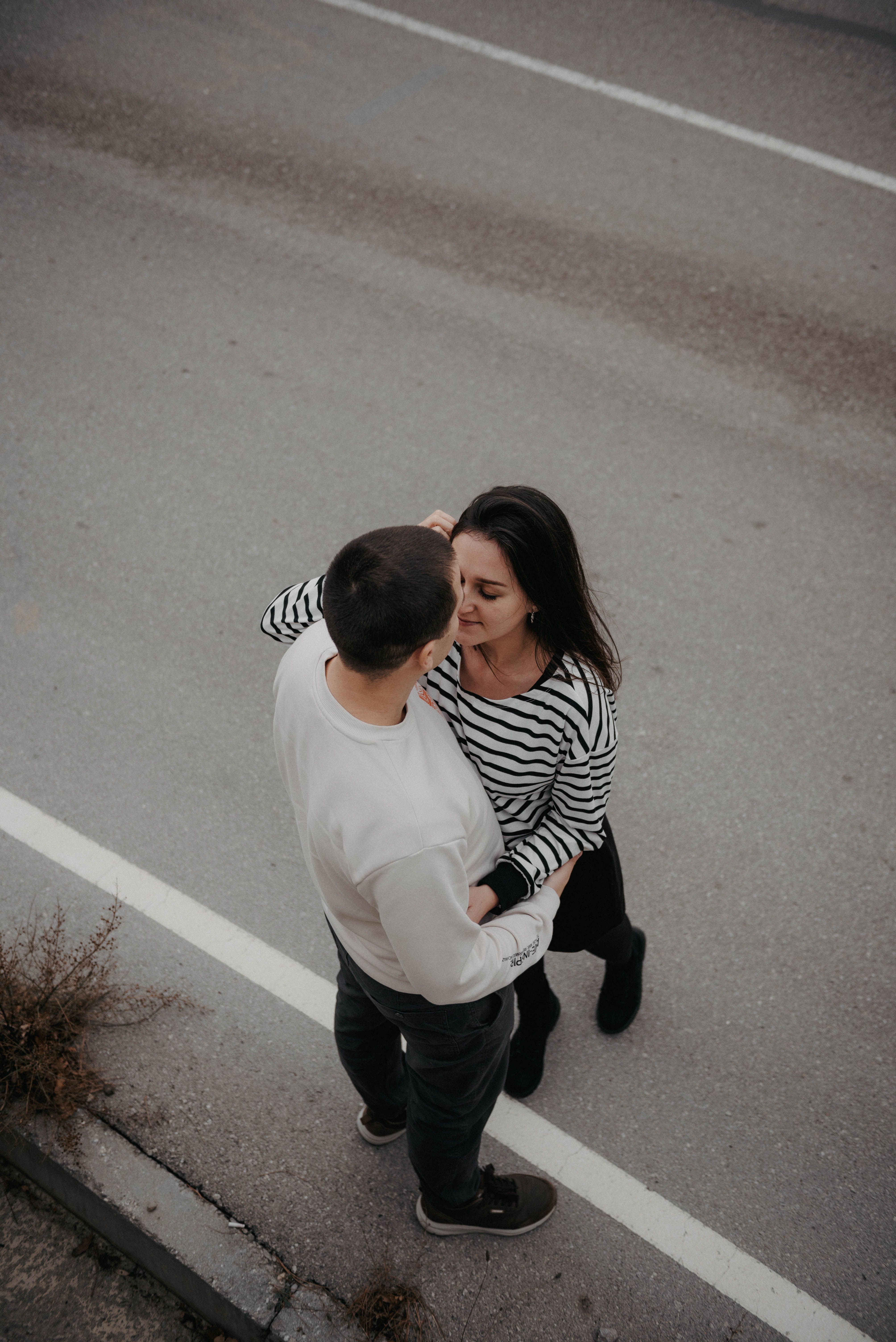 High-Angle Shot of a Romantic Couple Standing on Concrete Road · Free ...