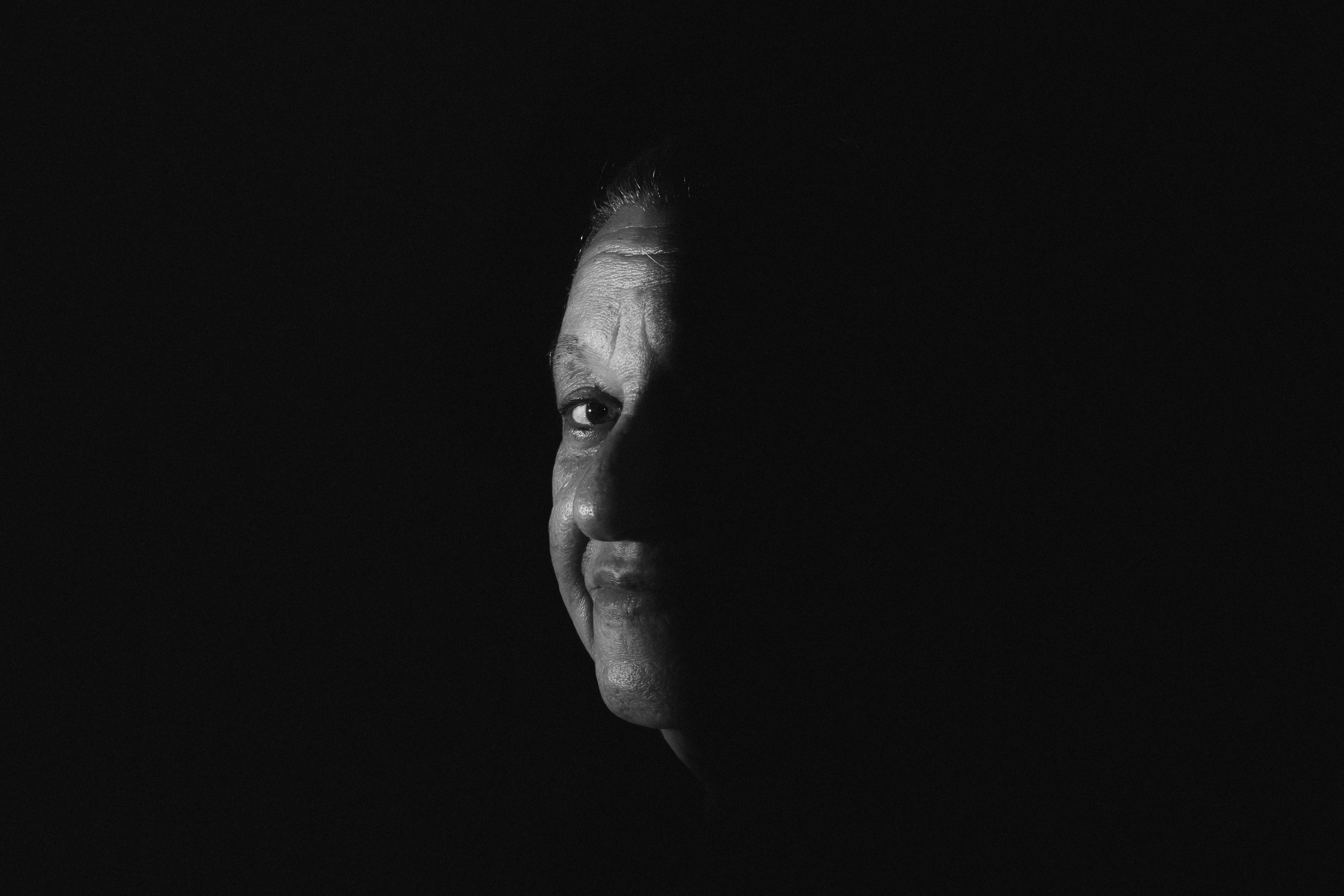 Grayscale Photo of a Person's Face in the Shadow · Free Stock Photo