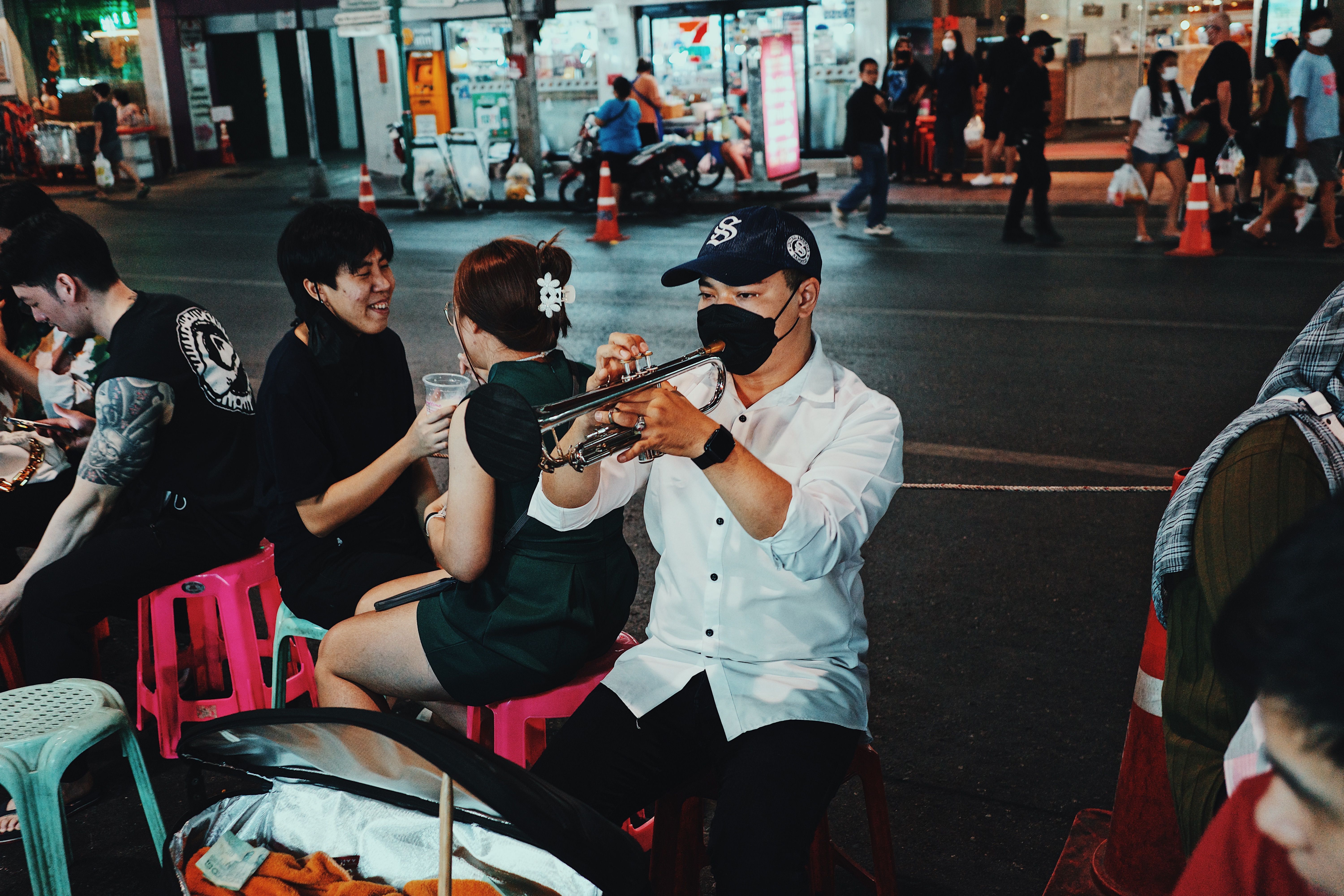 Man Playing a Trumpet on a Crowded Street at Night · Free Stock Photo