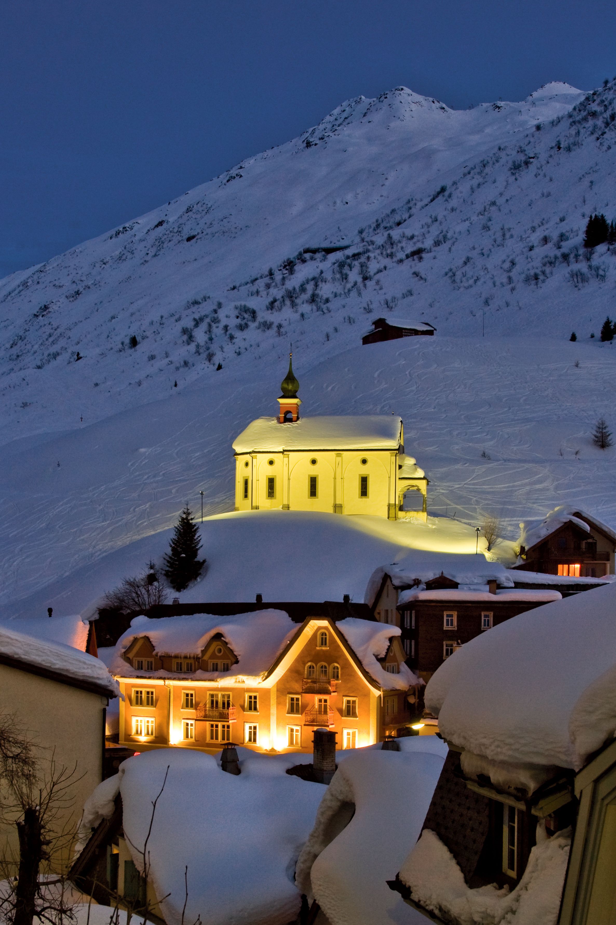 Snow Covered Buildings Near a Mountain · Free Stock Photo