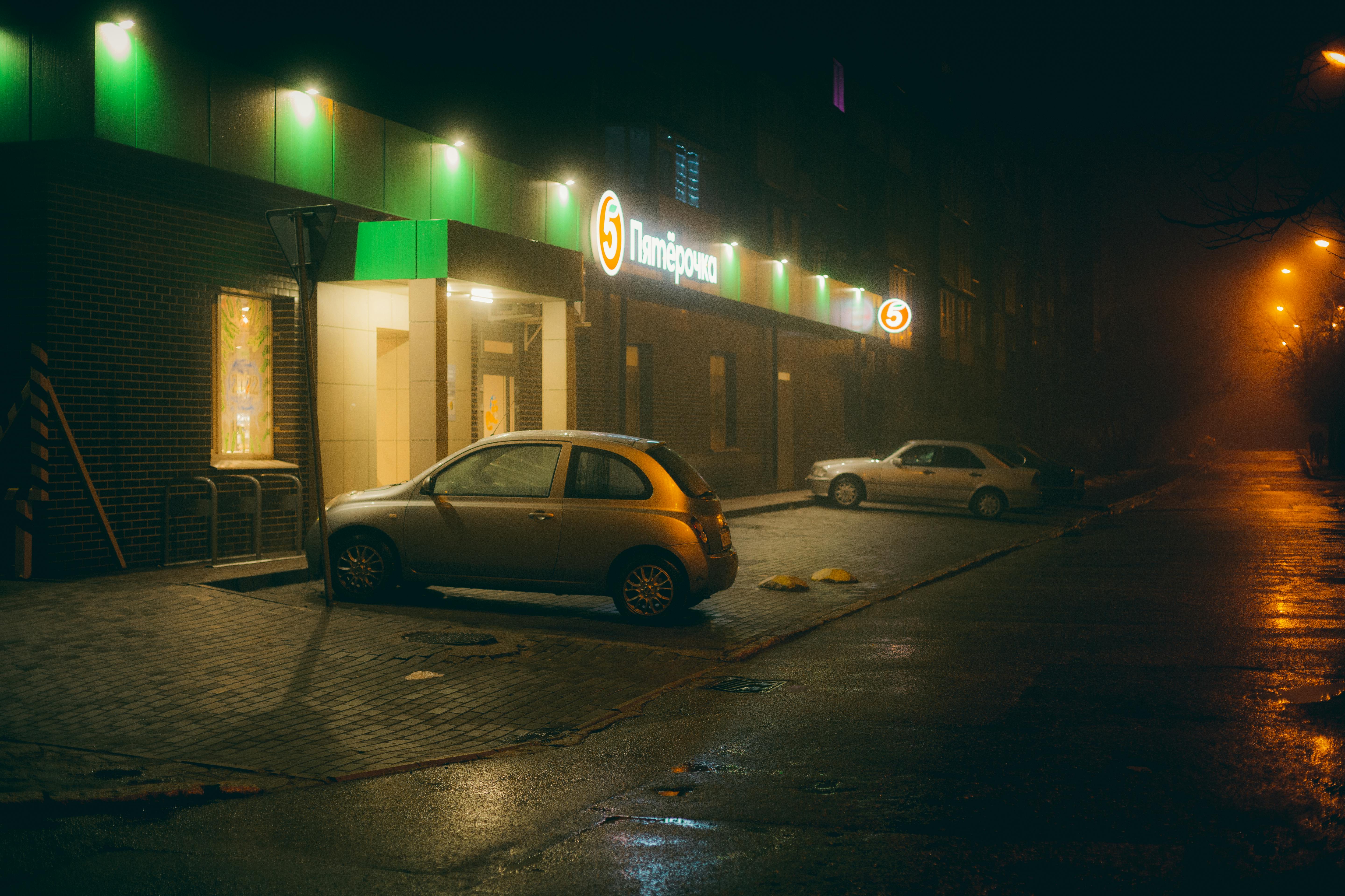 Cars Parked in the Parking Lot In Front of a Building · Free Stock Photo