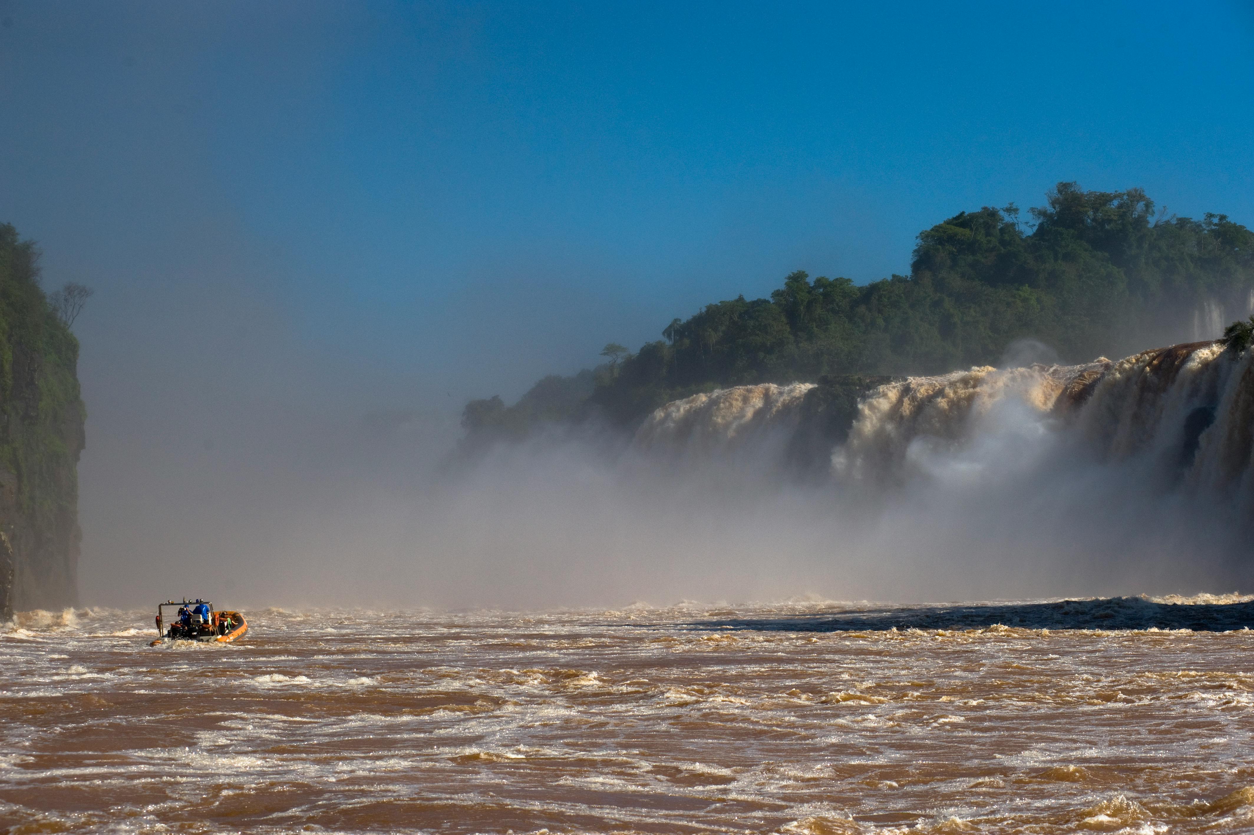 Raft on Water Near Waterfalls · Free Stock Photo