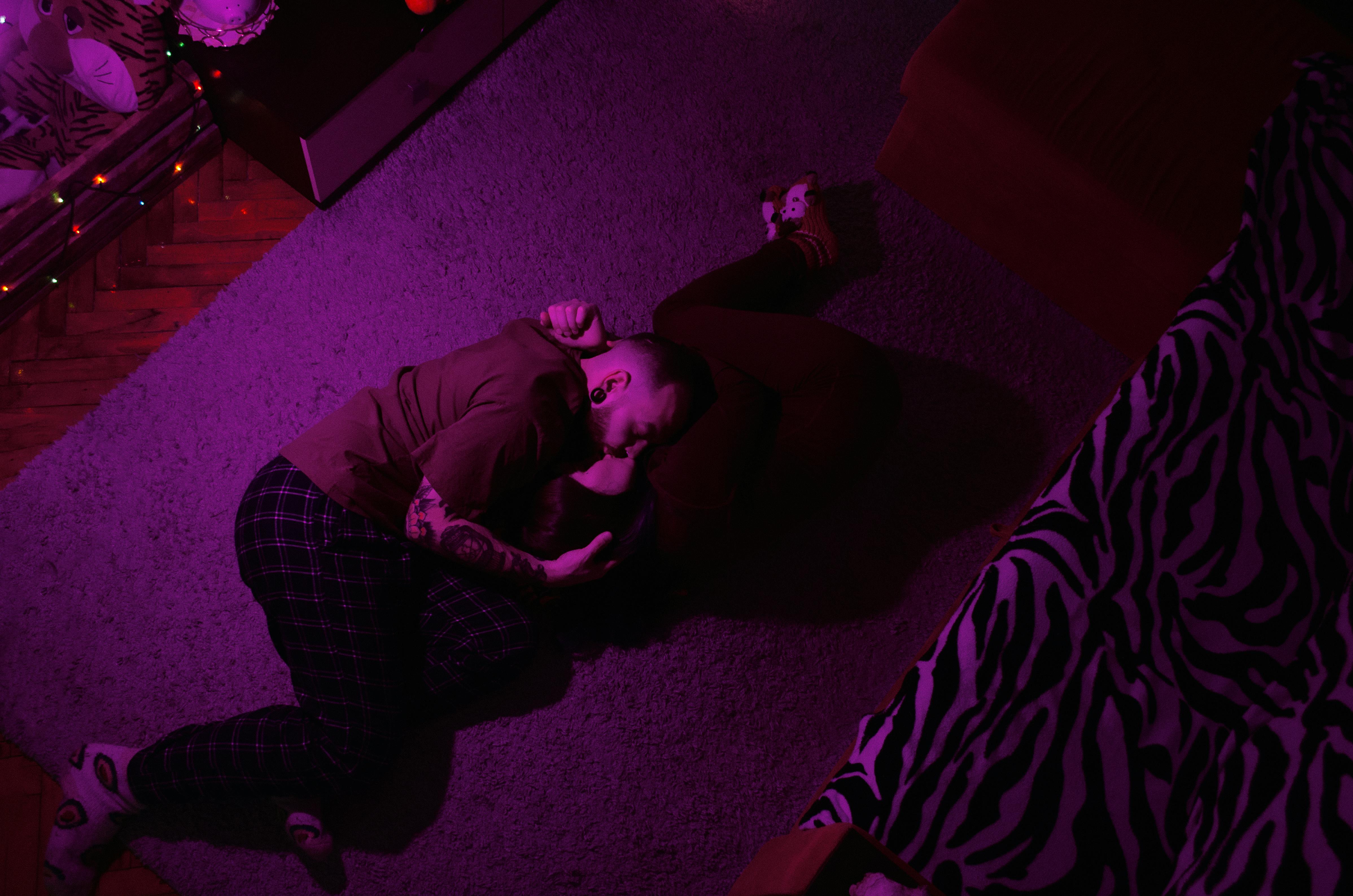 A Couple Kissing while Lying on Gray Rug · Free Stock Photo