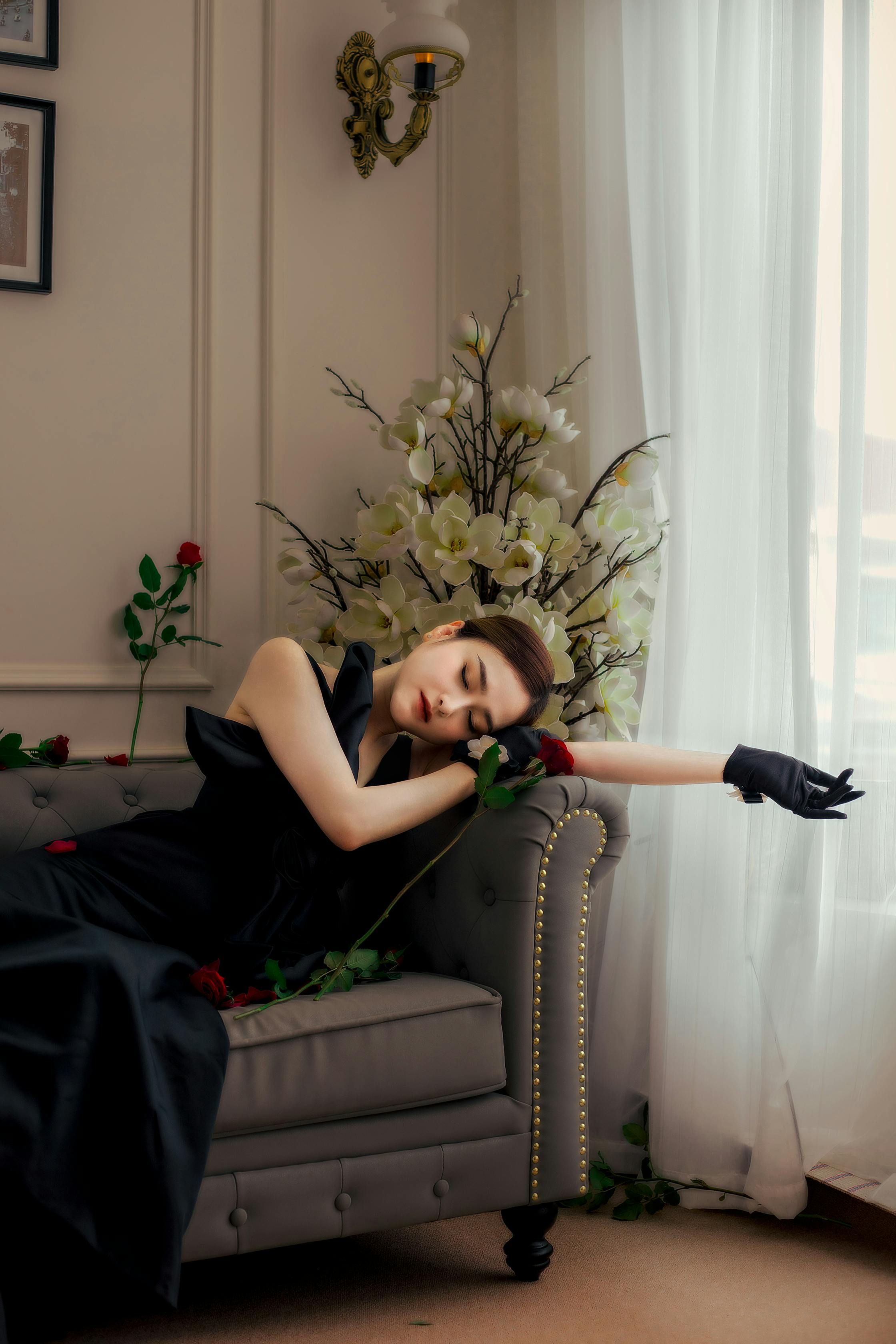 A Woman in Black Dress Lying on Brown Sofa · Free Stock Photo