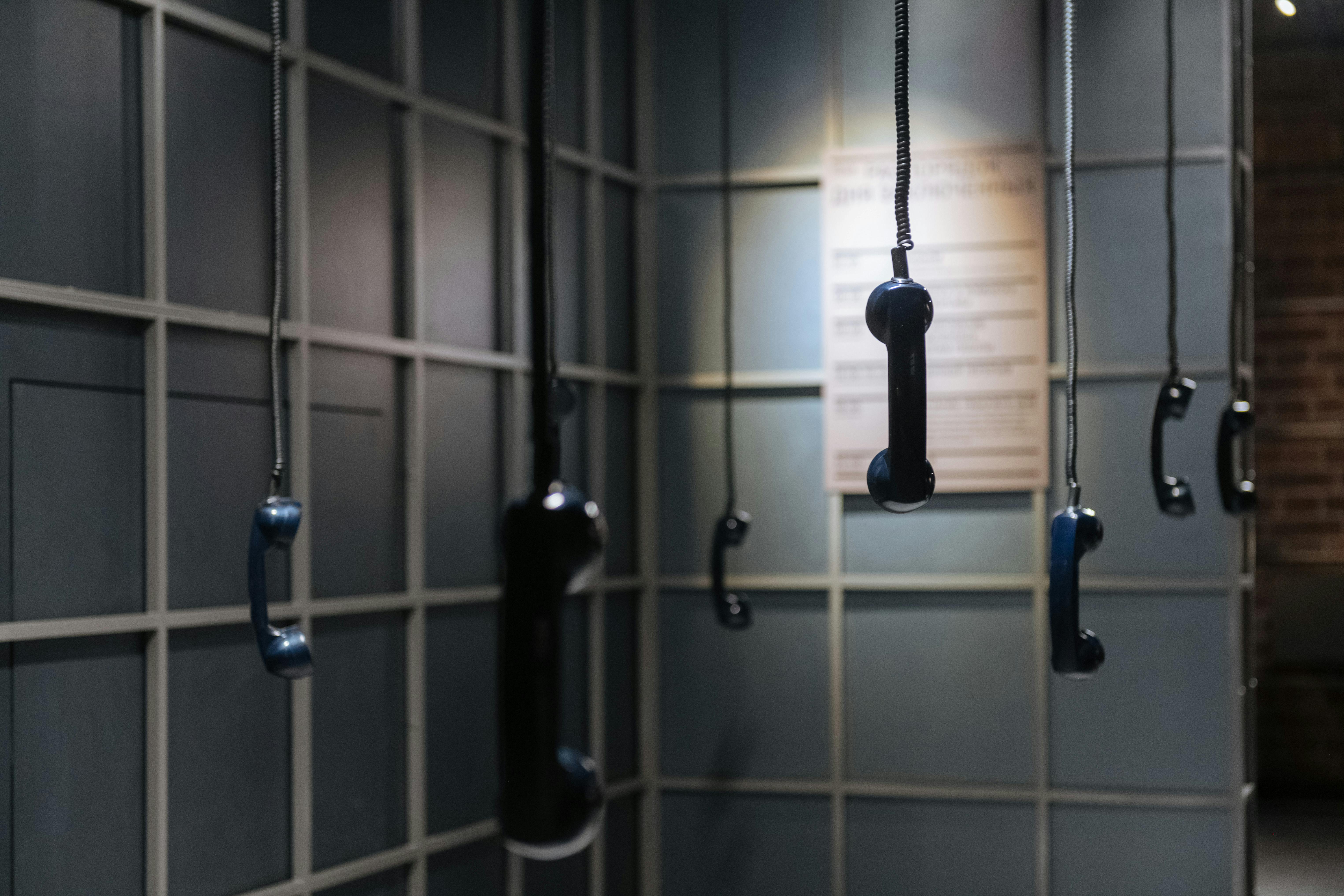 Phone Receivers Hanging from the Ceiling · Free Stock Photo