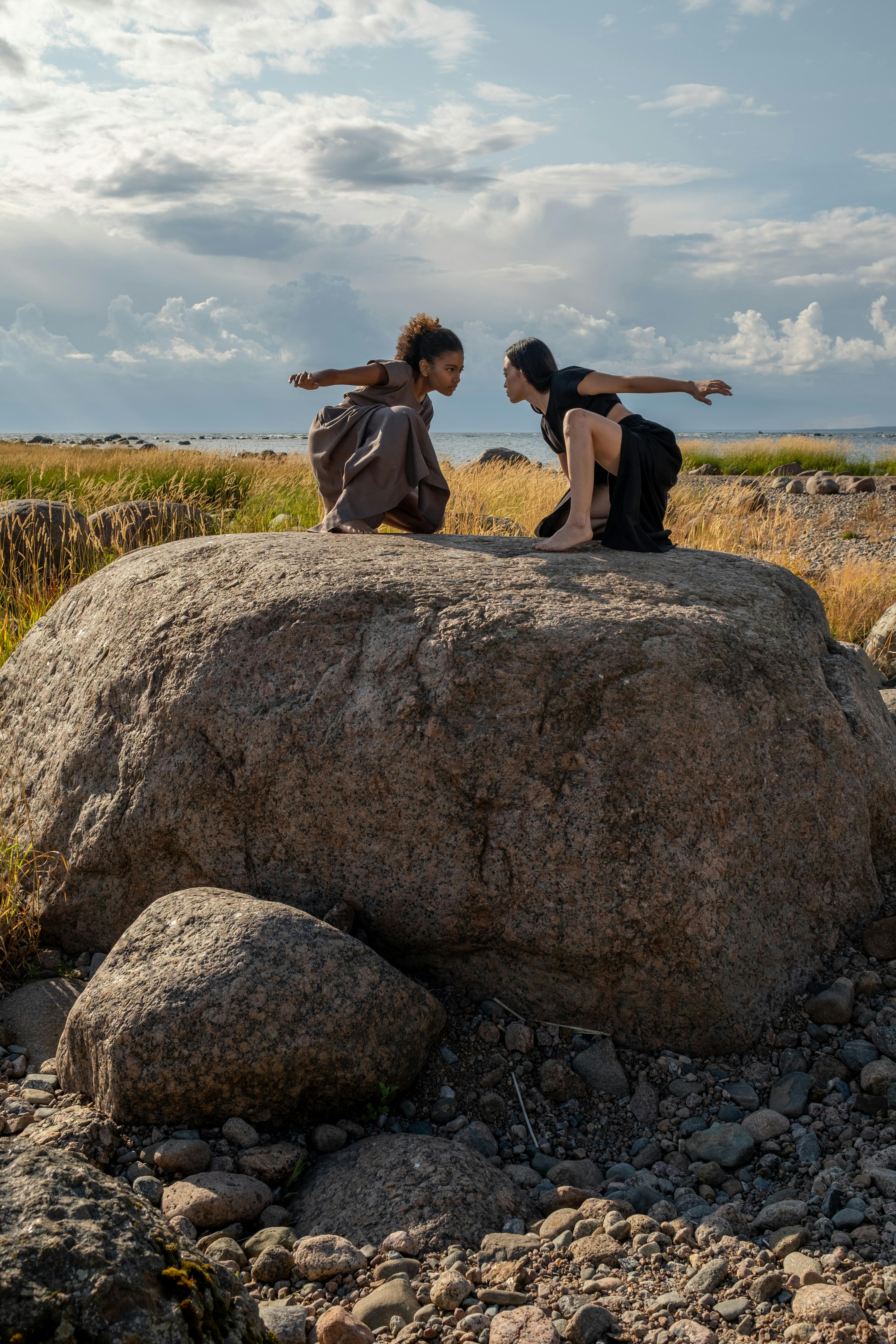 Women Sitting on a Big Rock · Free Stock Photo