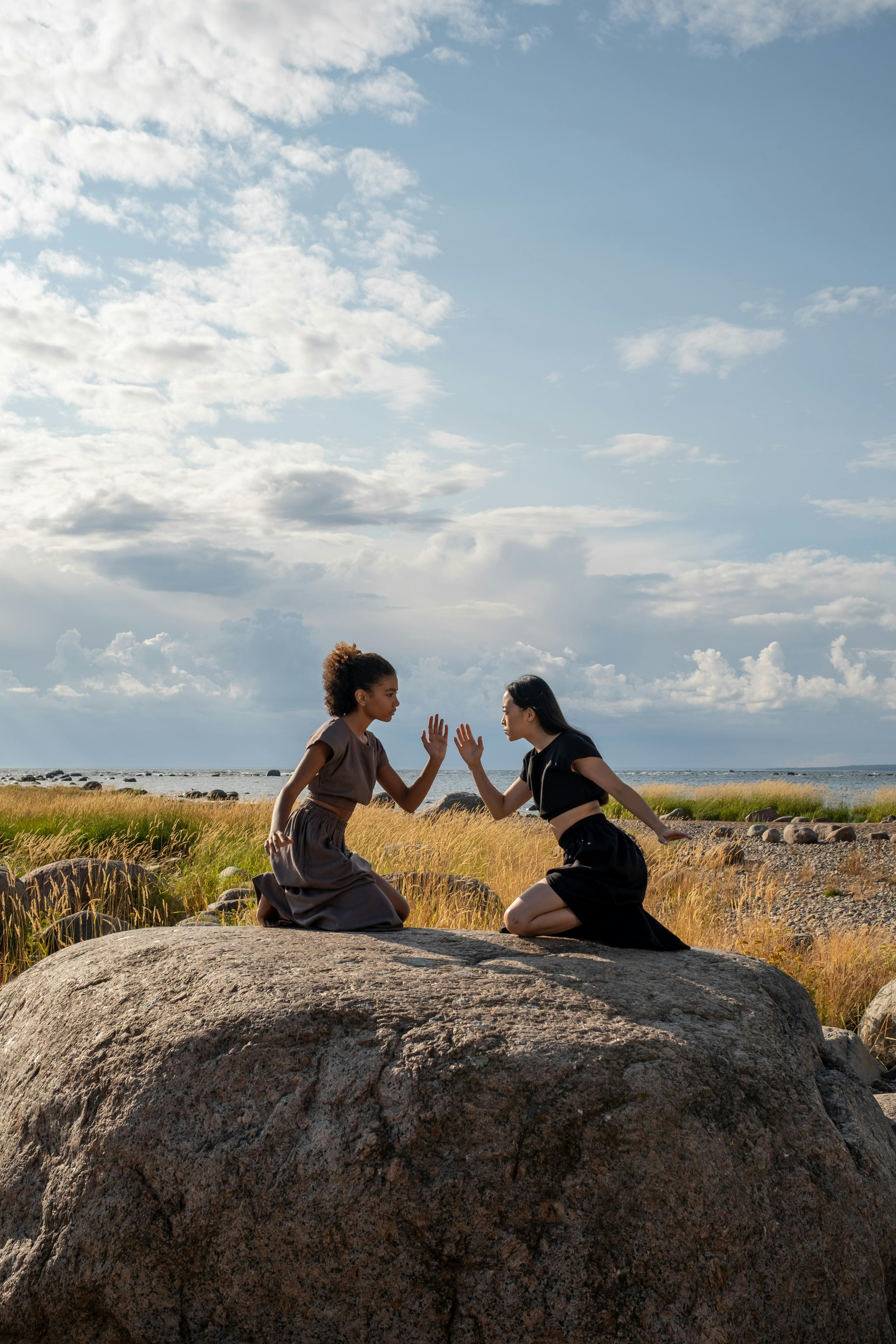 Women Sitting on a Big Rock · Free Stock Photo