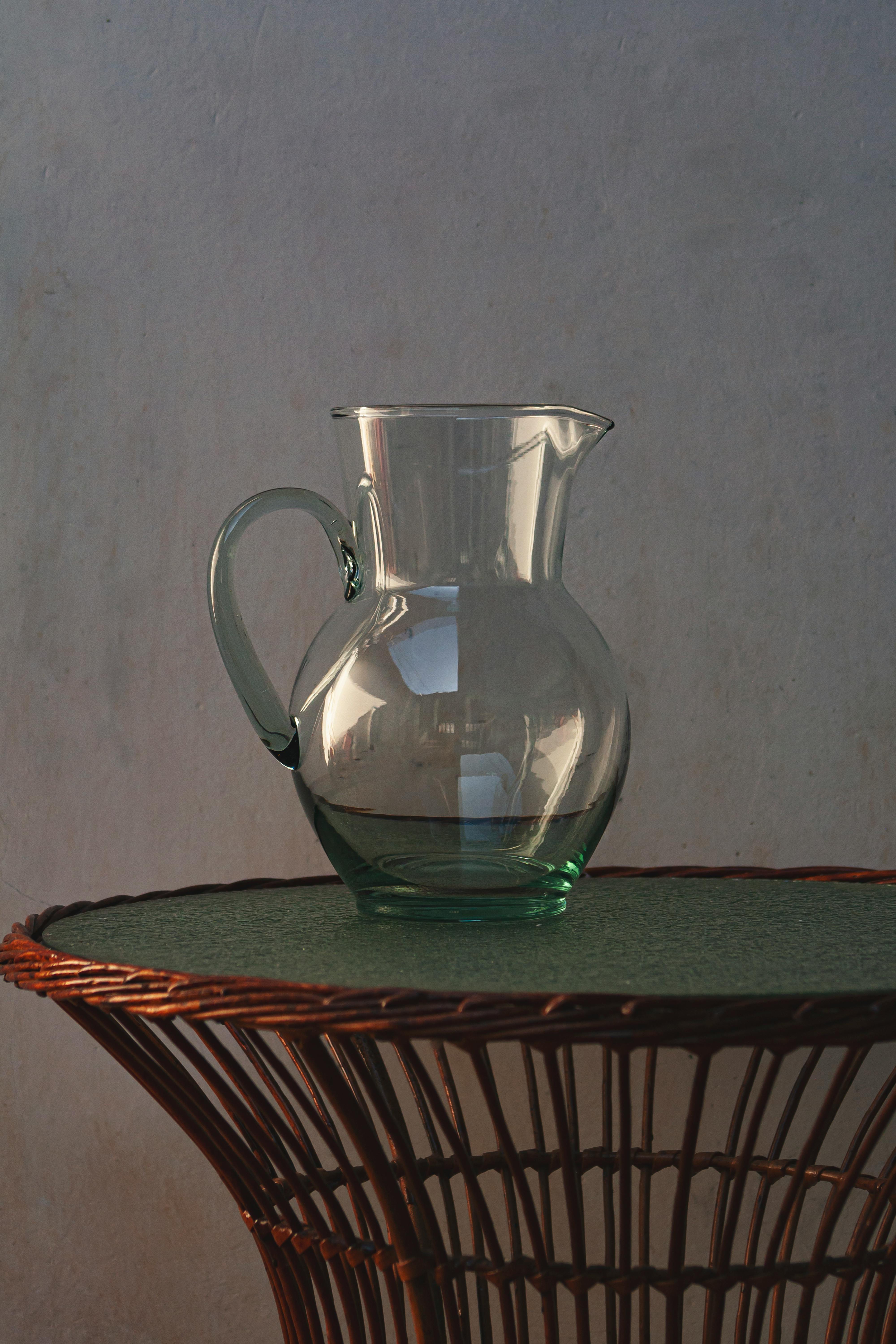 Glass Pitcher on a Round Table · Free Stock Photo